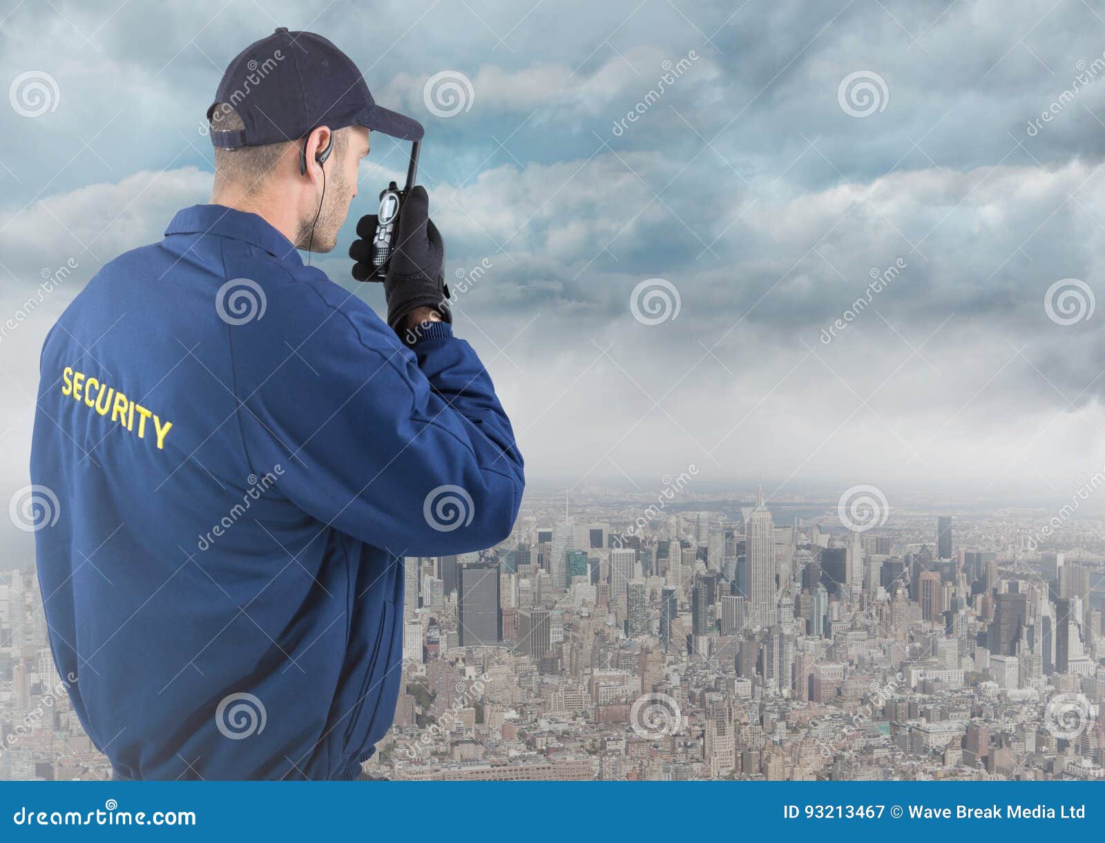 Back of Security Guard with Walkie Talkie Against Skyline and Clouds ...