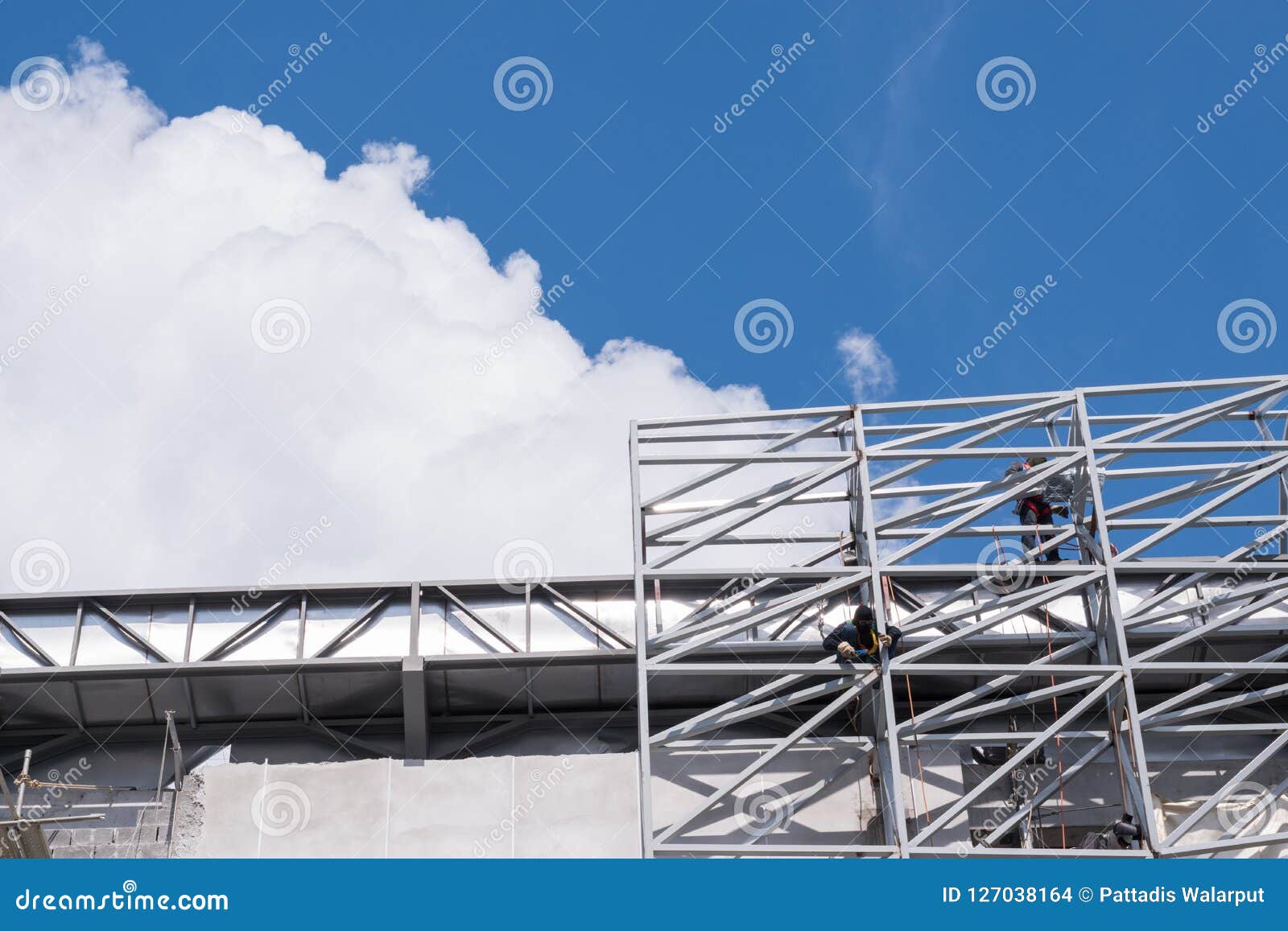 Back Side of Construction Workers are Working on Top of Building ...