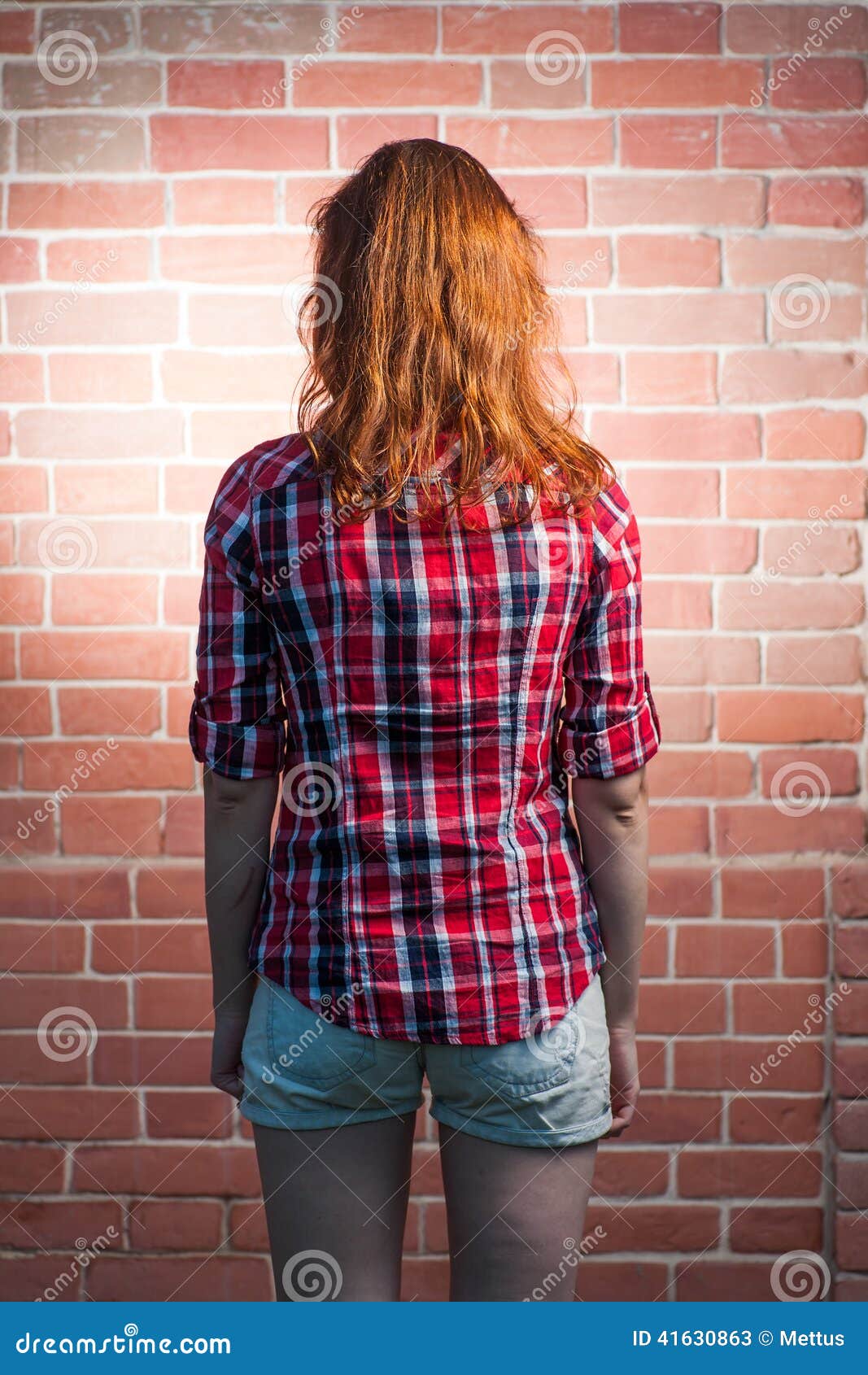 Back Side View of a Redhead Female Befor Red Brick Wall. Stock Image ...