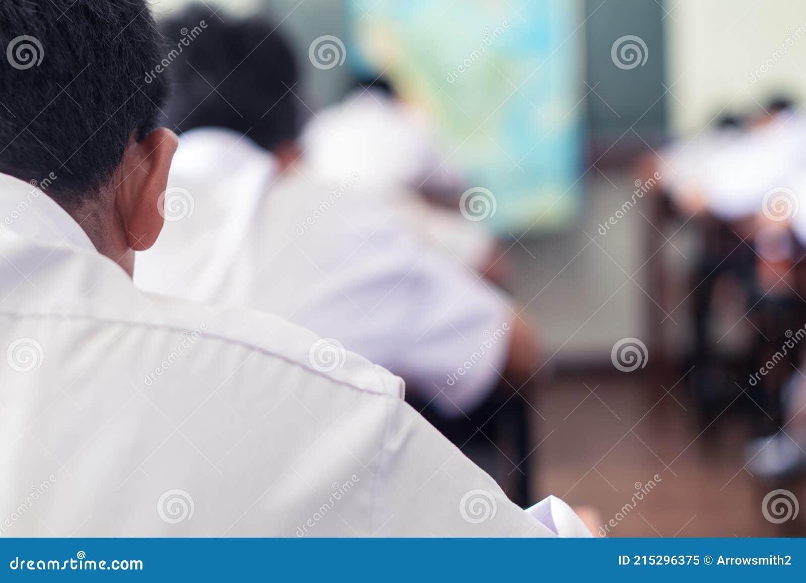 Back of Students Taking Exam and Writing Answer in Classroom with ...