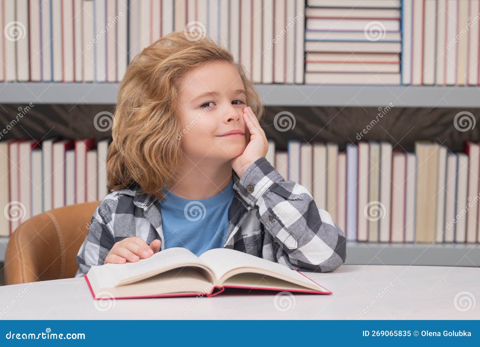 Back To School. Child Reading a Book in a School Library. School Boy ...
