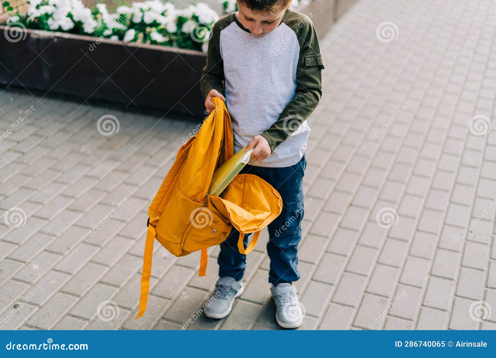Back To School. Cute Child Packing Backpack, Holding Notepad and ...