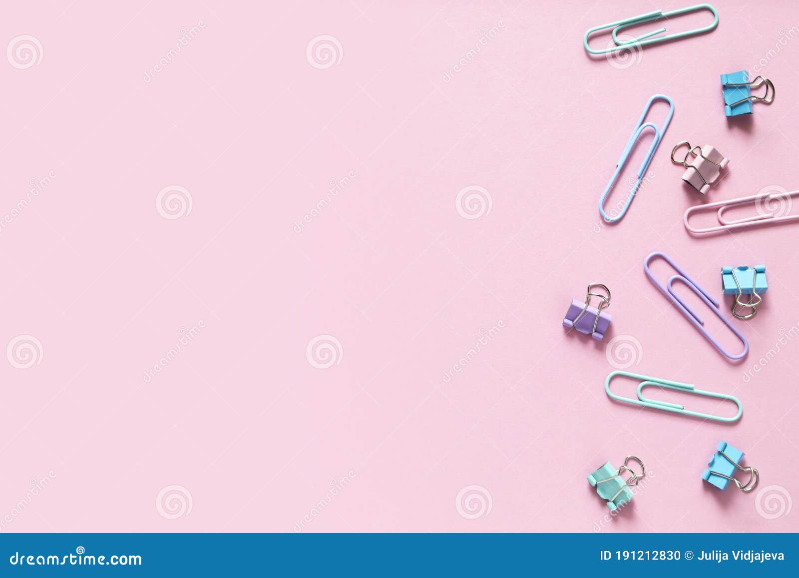 Back To School. Multi-colored Paper Clips Laid Out on a Delicate Pink ... Back To School. Multi-colored Paper Clips Laid Out on a Delicate Pink ...