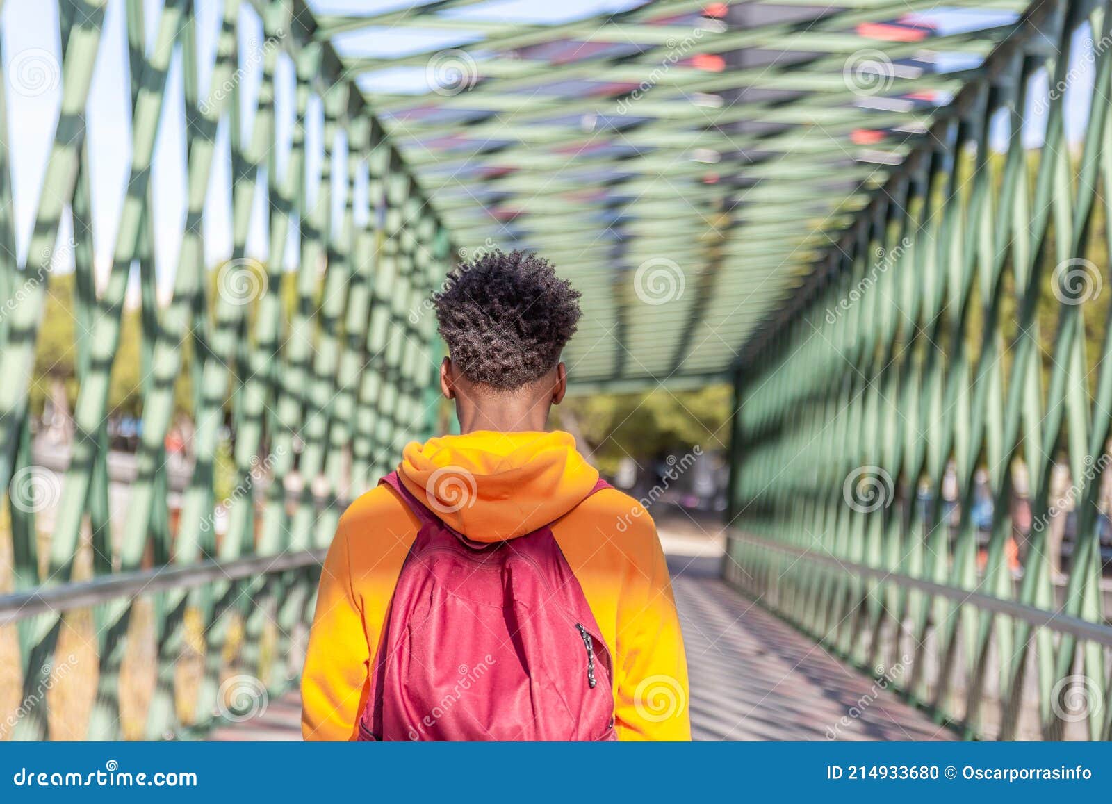 Back View of an Afro Style Boy Walking Inside a Metal Bridge Stock ...