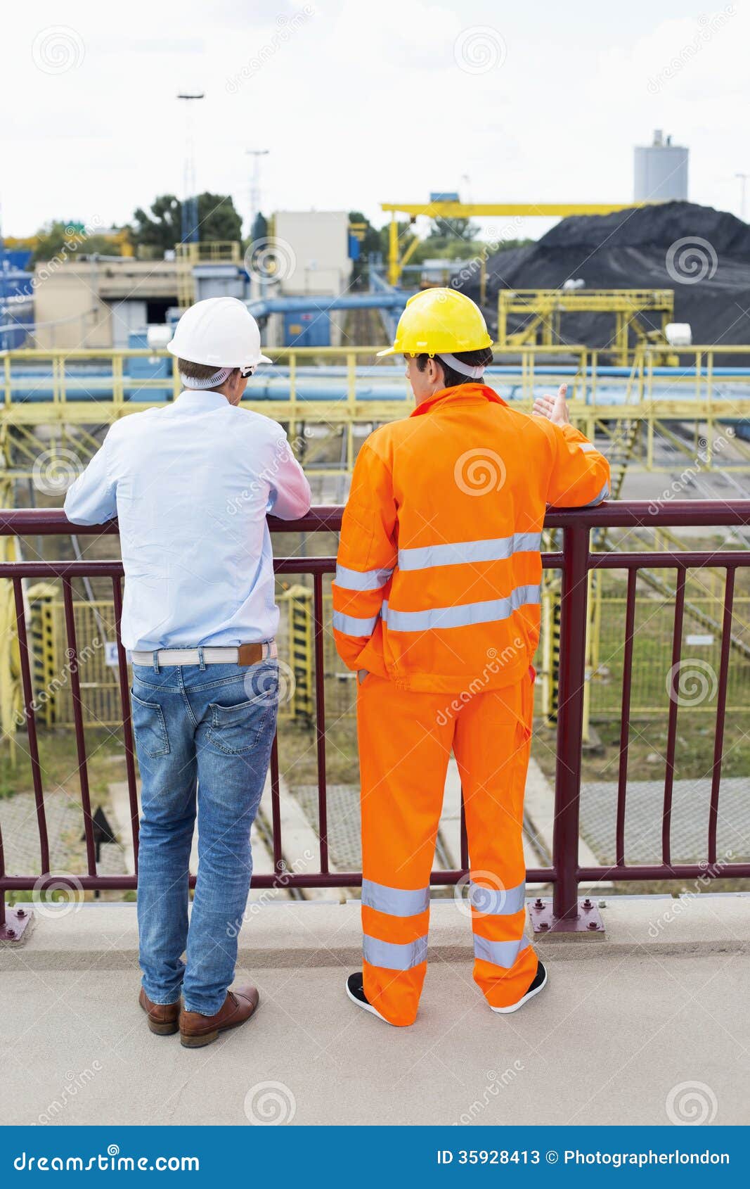 Back View of Architects Standing Against Railing at Construction Site ...