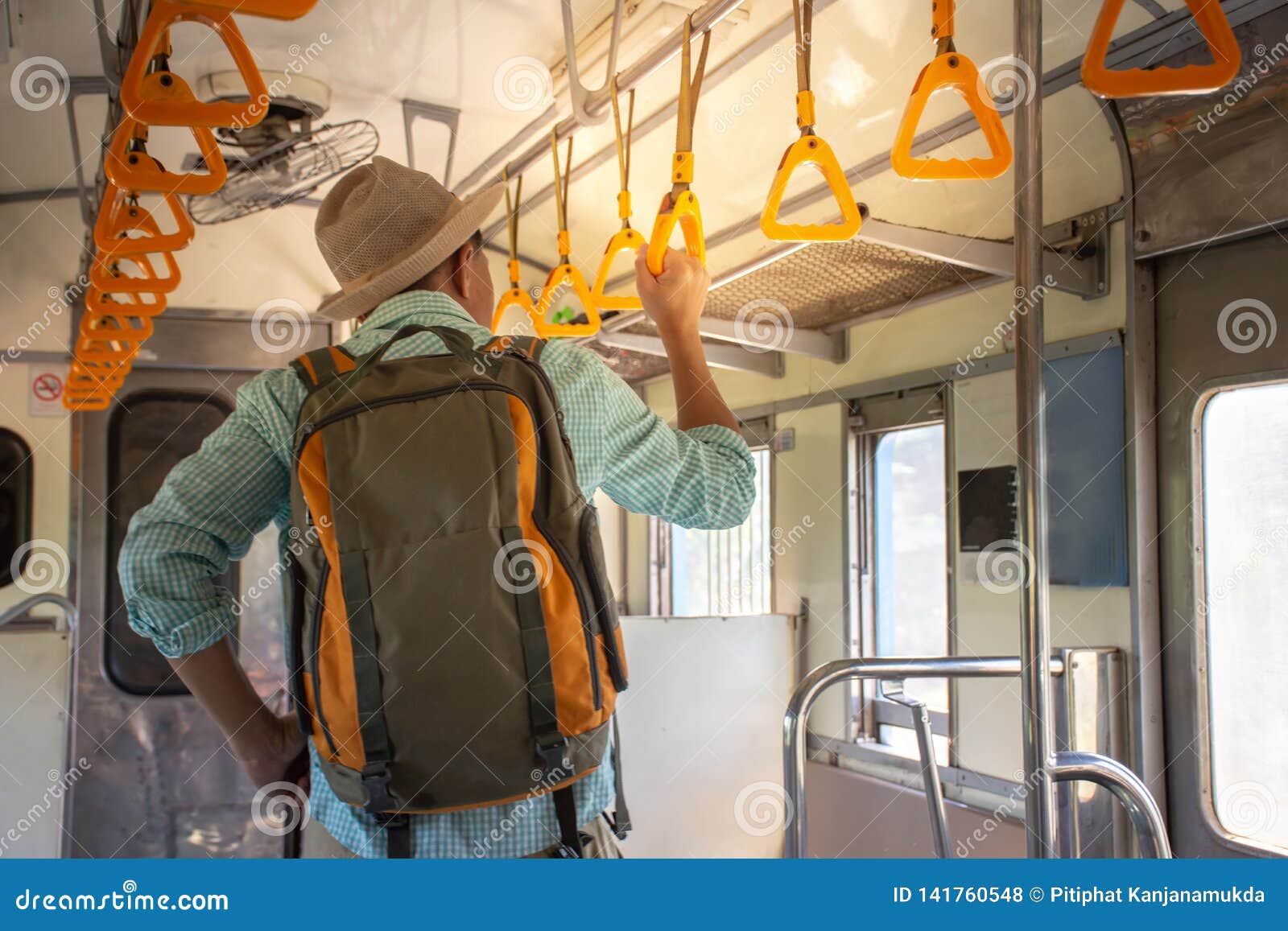 Back View of Asian Backpackers Holding Handrail Inside the Train Stock ...