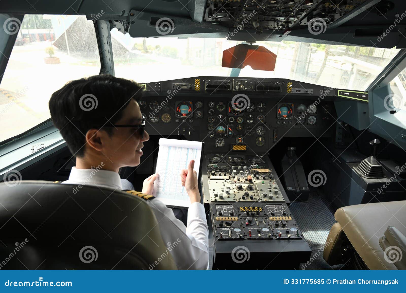 Back View of Asian Pilot Dressed in a Uniform Preparing for Flight in ...