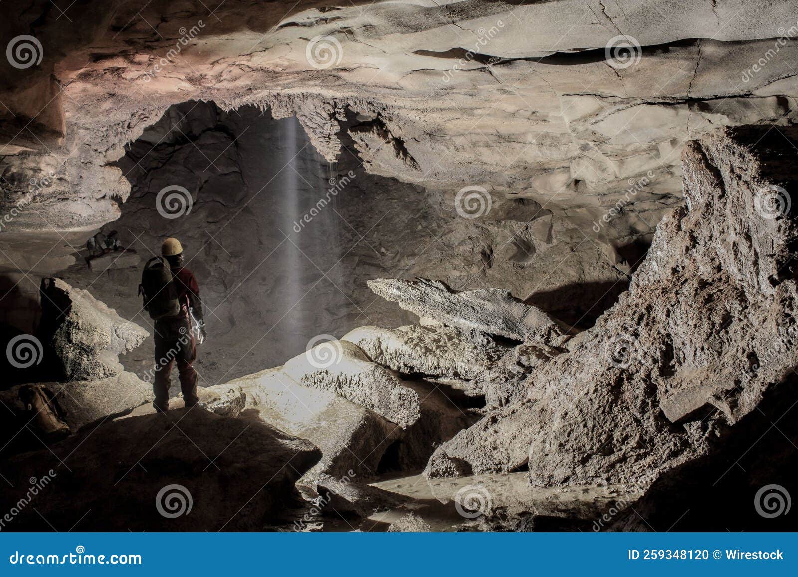 Back View of a Backpacker Hiking through a Cave Stock Photo - Image of ...