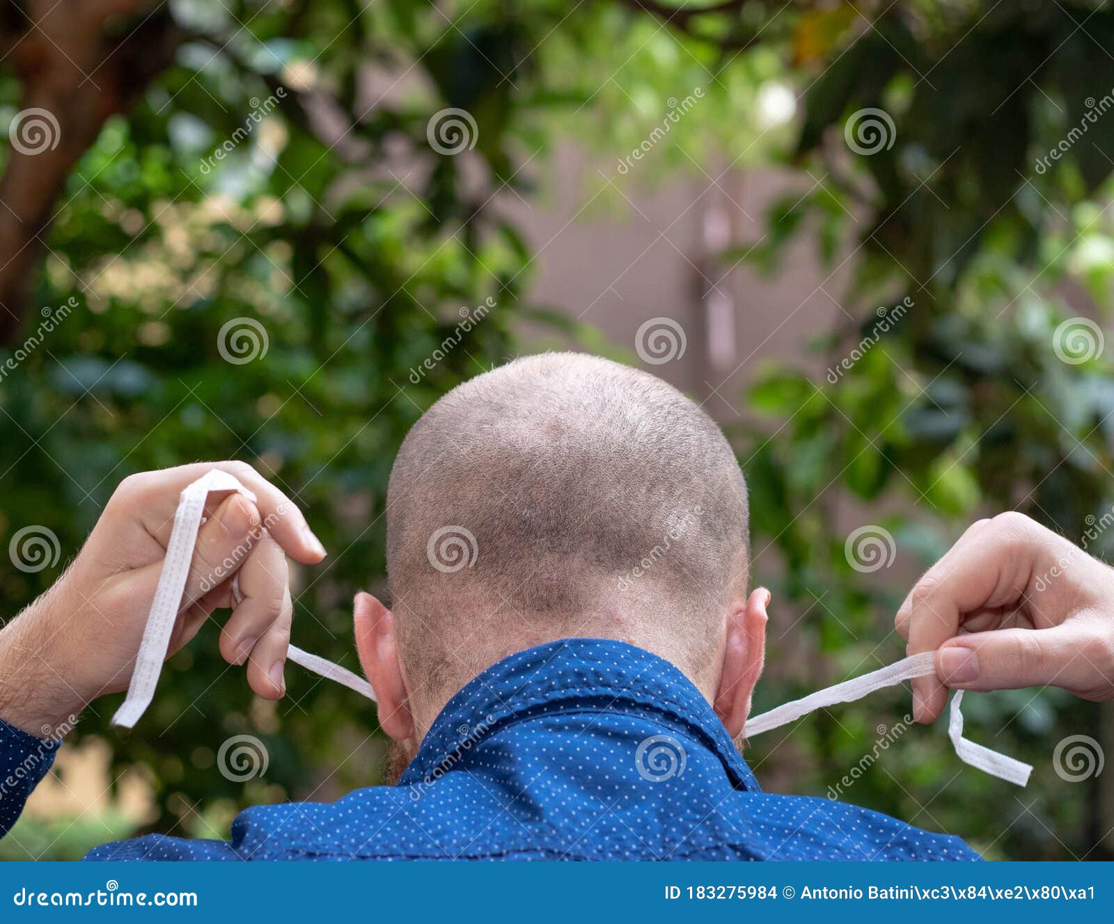 Back View of a Bald Man Putting on a Face Mask Stock Photo - Image of ...