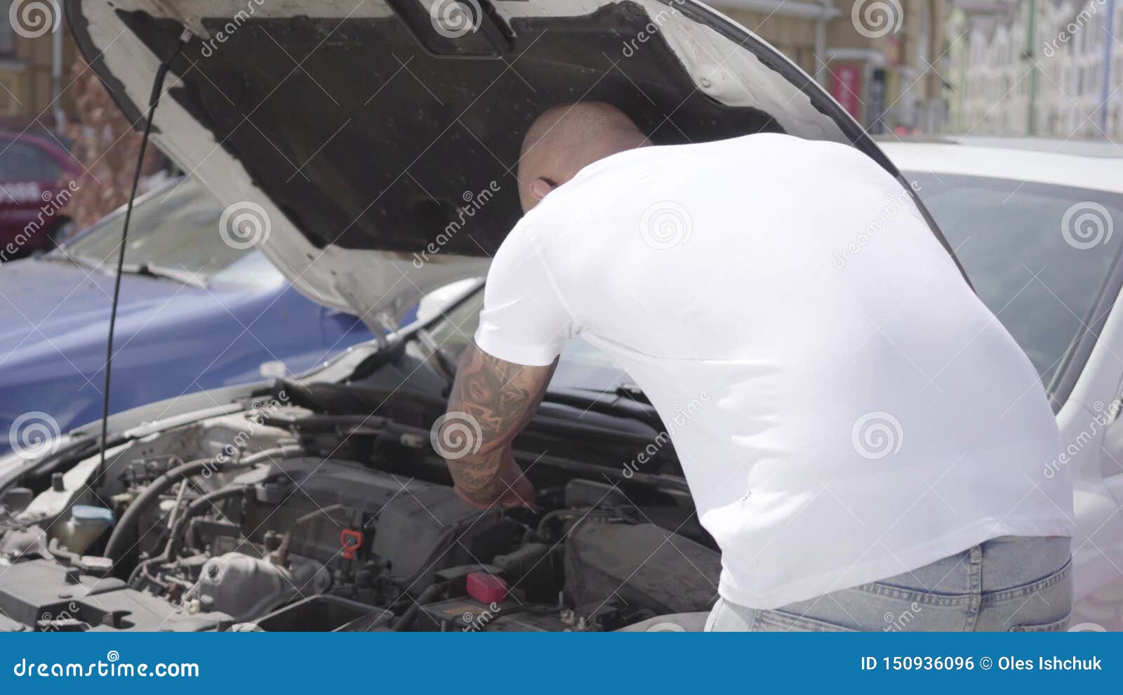 Back View of Bald Middle Eastern Man Looking Under the Car Hood. the ...