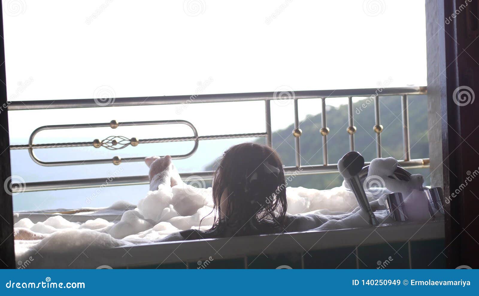 Back View Of Bathing Young Woman Relaxing In Bathtub Of Foam Raising
