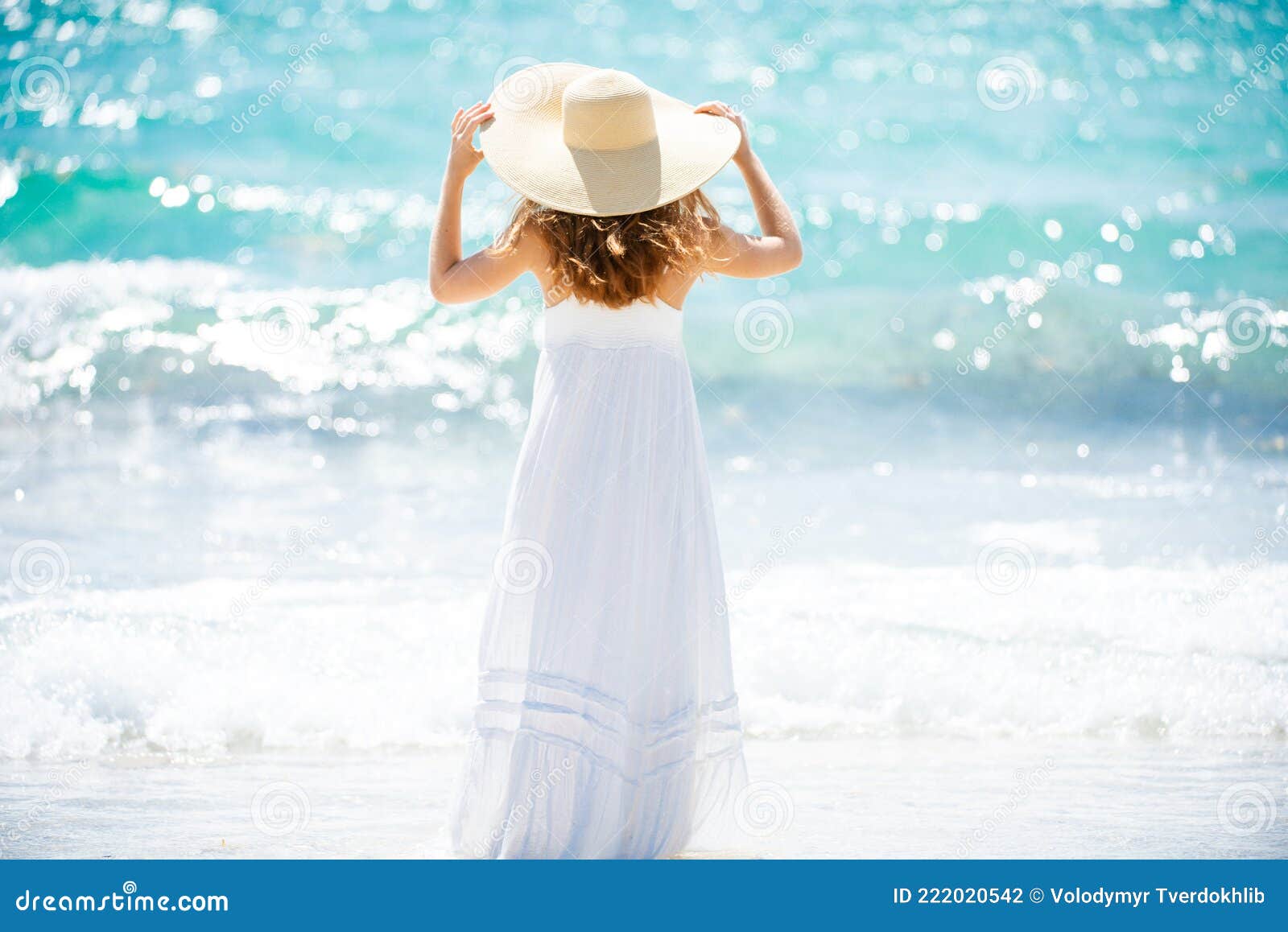 Back View Beautiful Girl With Straw Hat Enjoying Sunbath At Beach