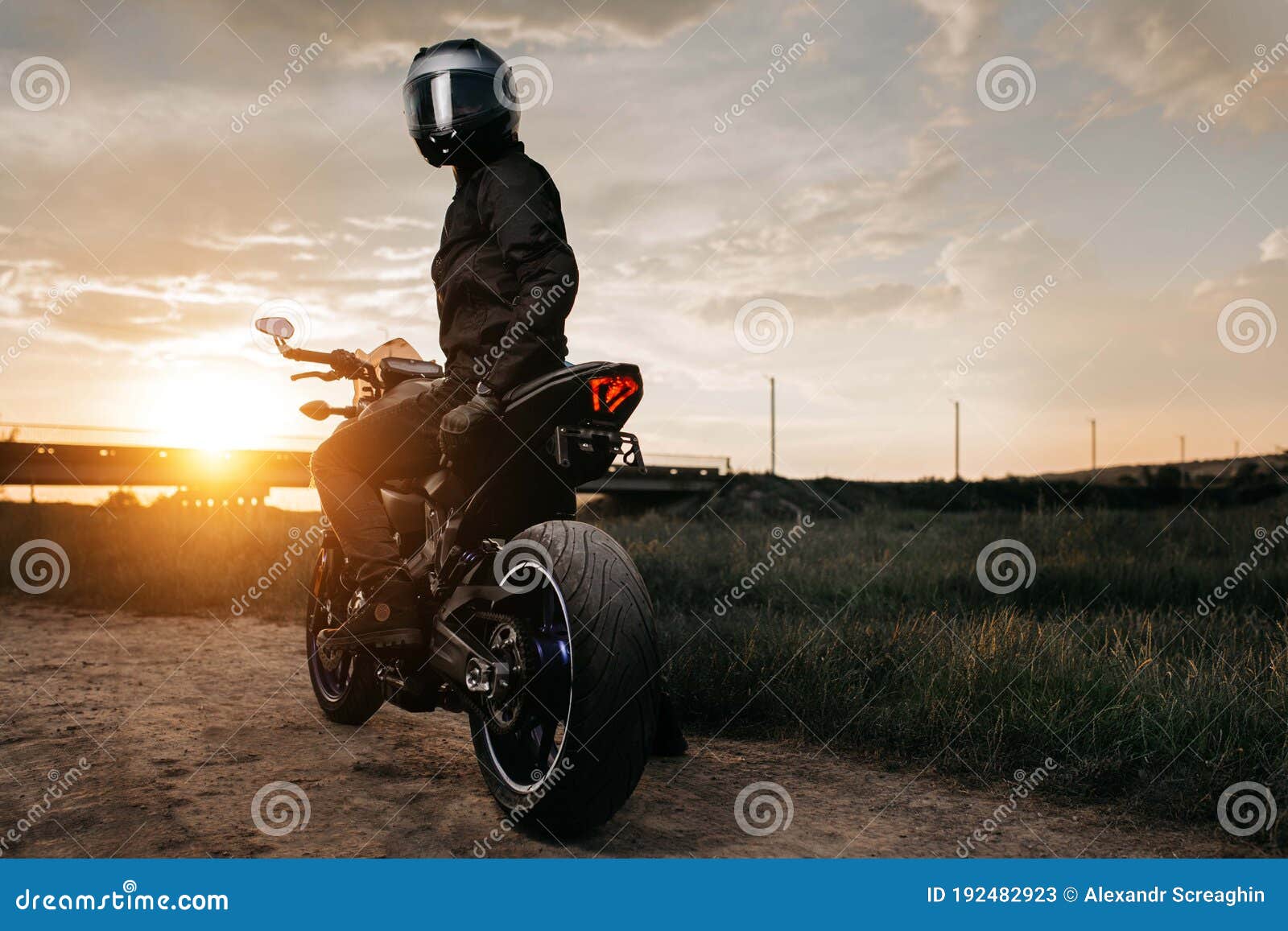 Back View of Biker Sitting on Motorcycle in Sunset on the Country Road ...