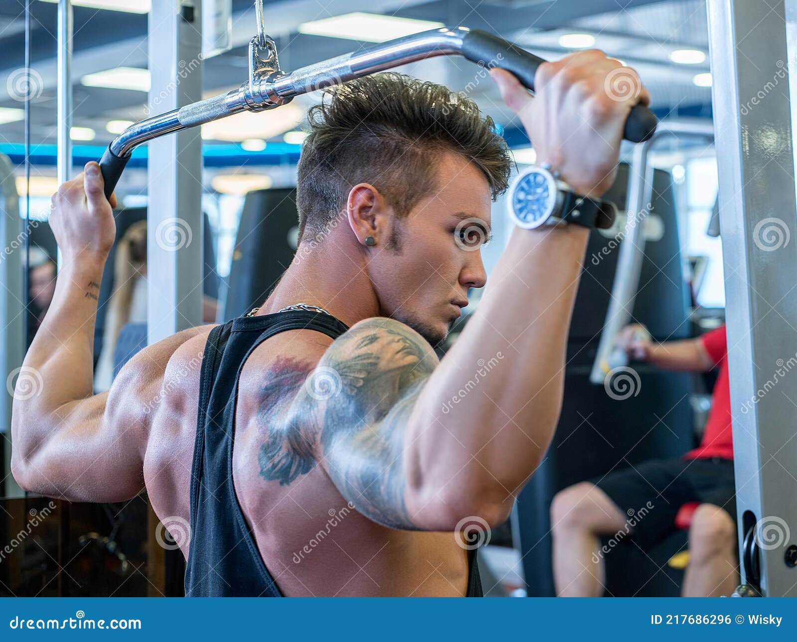 Back View of Bodybuilder Exercising on Simulator Stock Photo - Image of ...