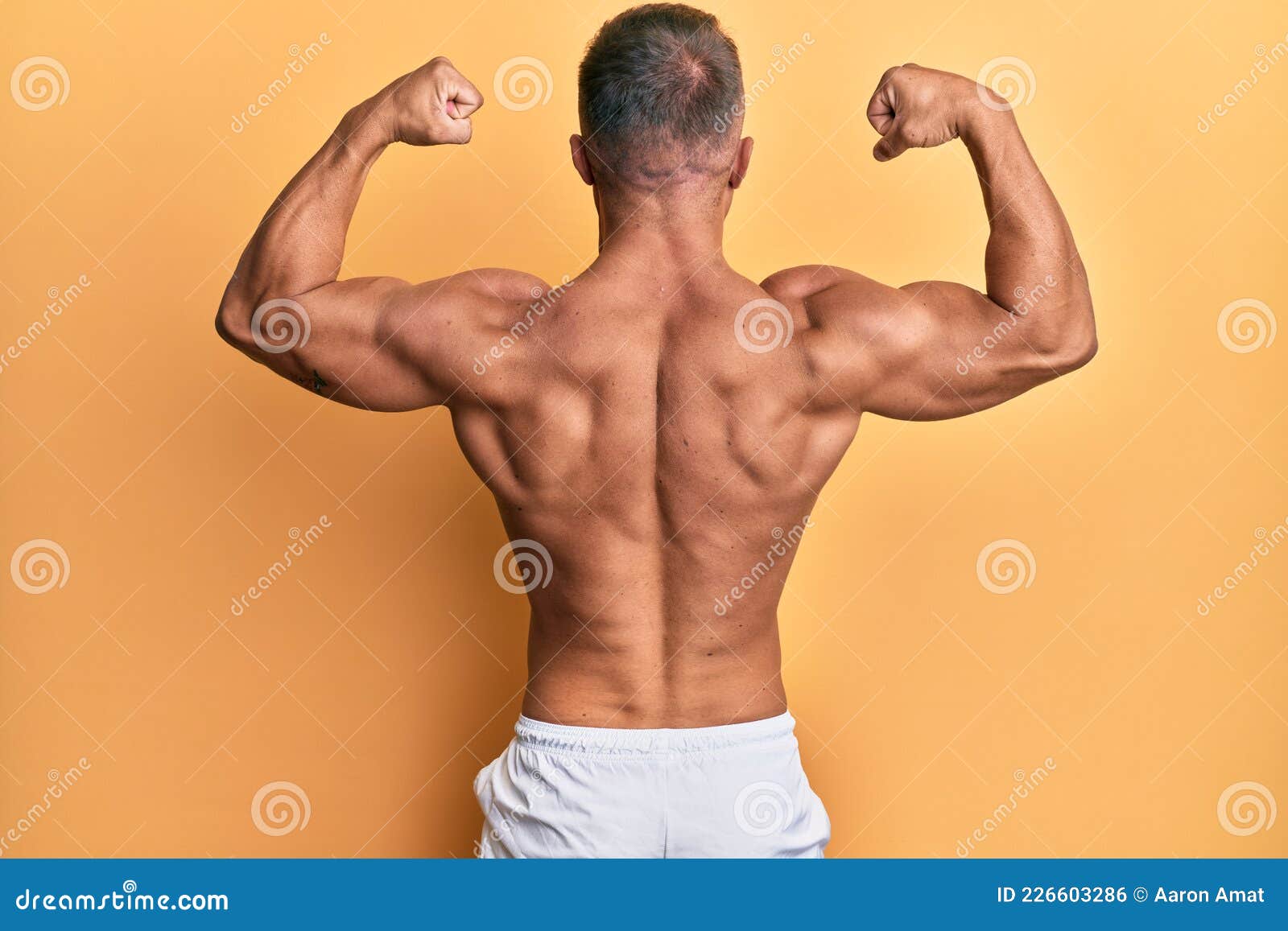 Back View of Bodybuilder Man, Posing Showing Back Muscle Stock Photo ...