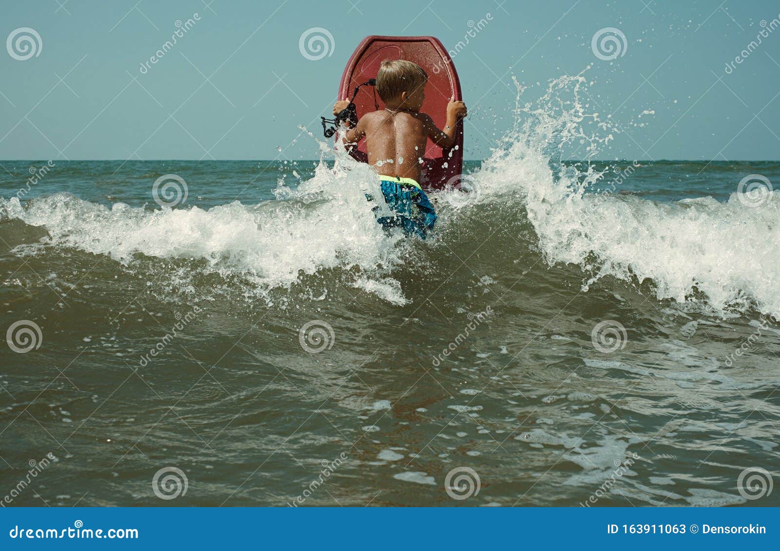 Boy jumping with bodyboard stock image. Image of surfing - 163911063