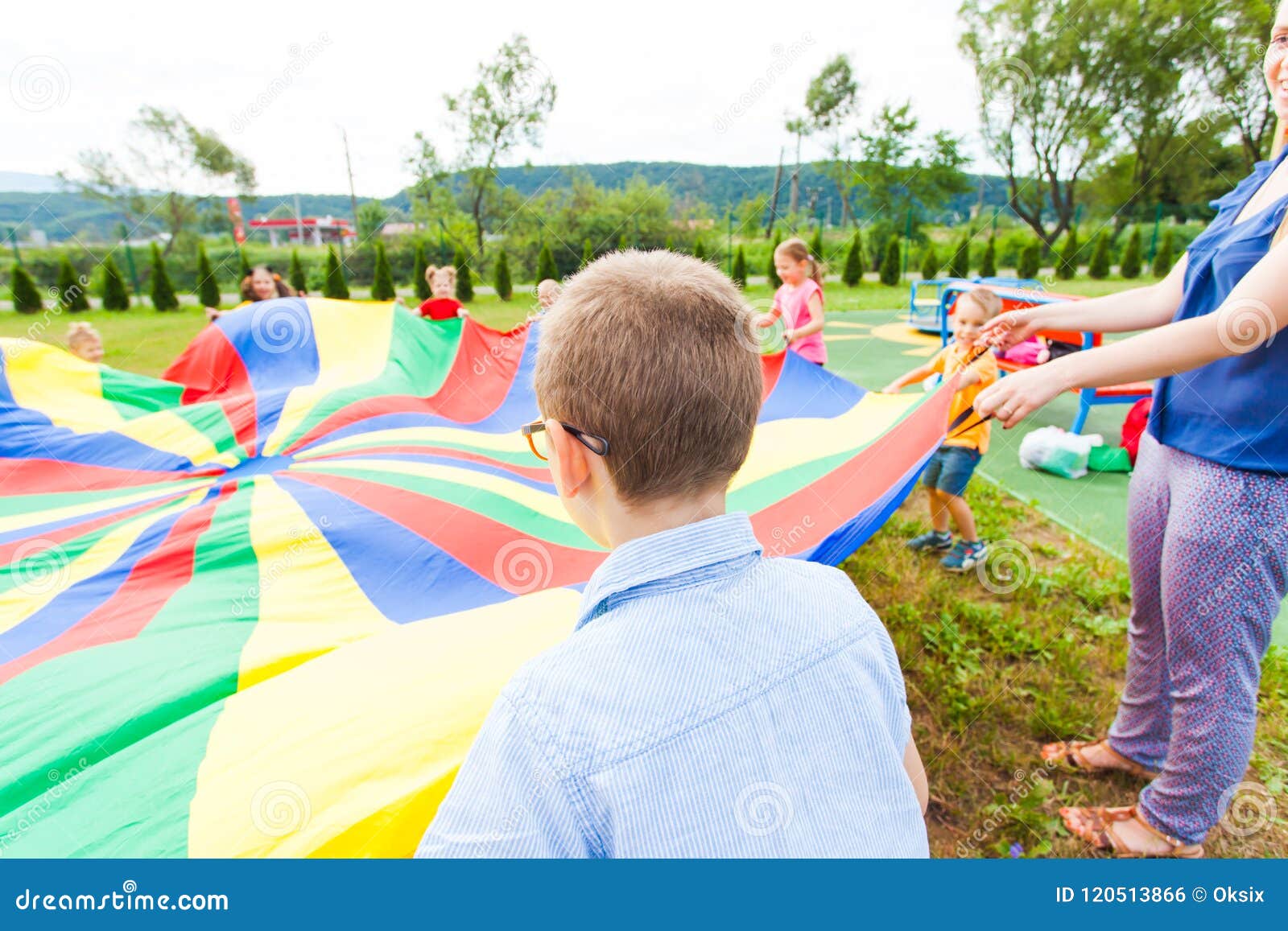 The Back View of a Boy with Large Parachute in His Hands Stock Photo ...