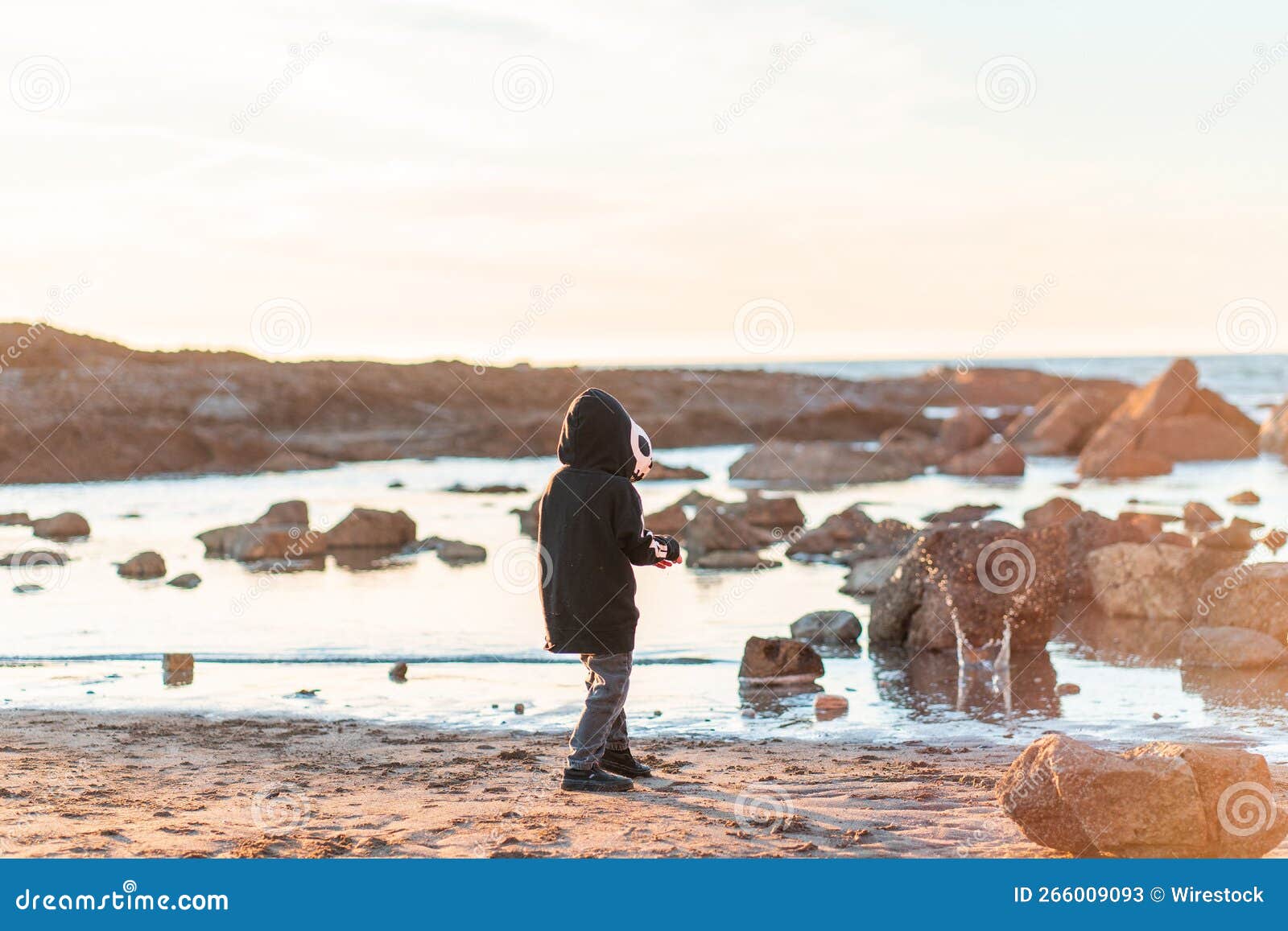 Back View of Boy Standing in Front of Rocky River during Sunset Stock ...