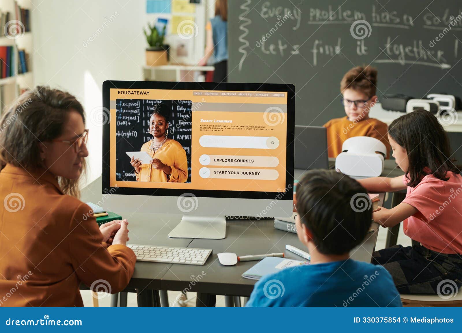 Back View of Boy Using Computer in School with Teacher Stock Photo ...