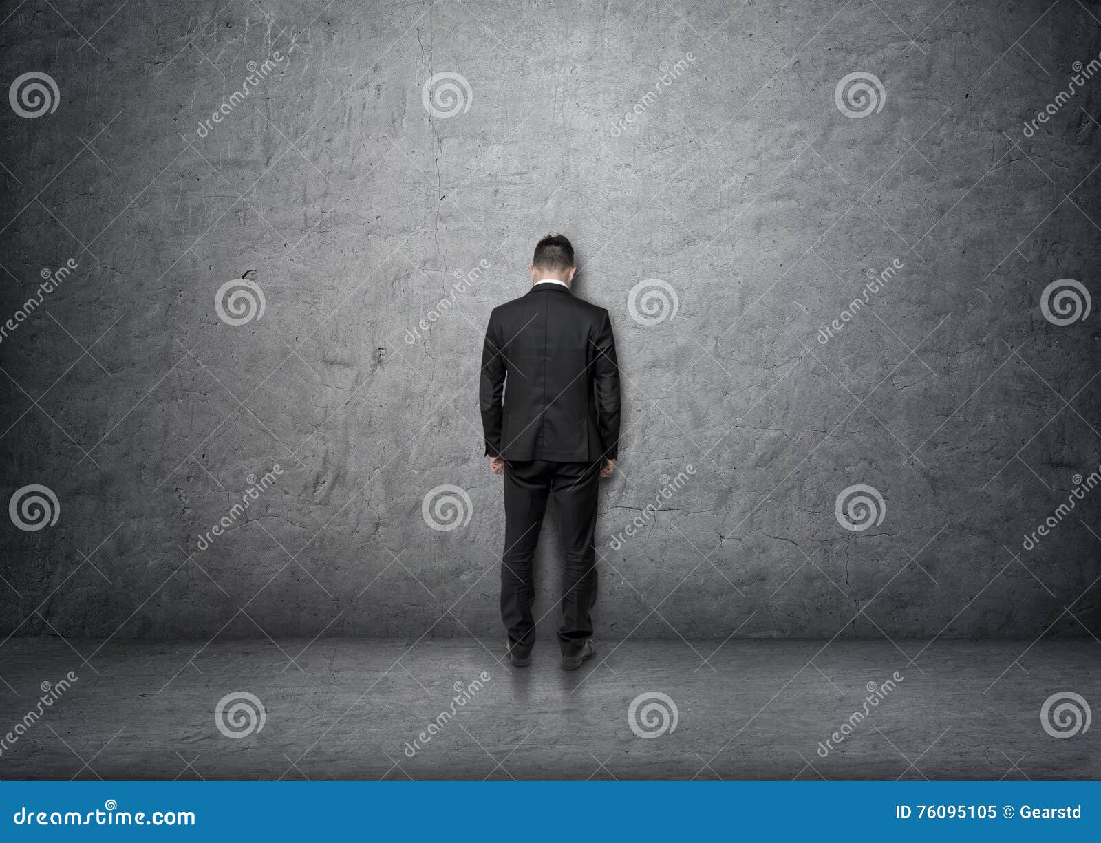 Back View Businessman with Bowed Head Standing in Front of Concrete ...