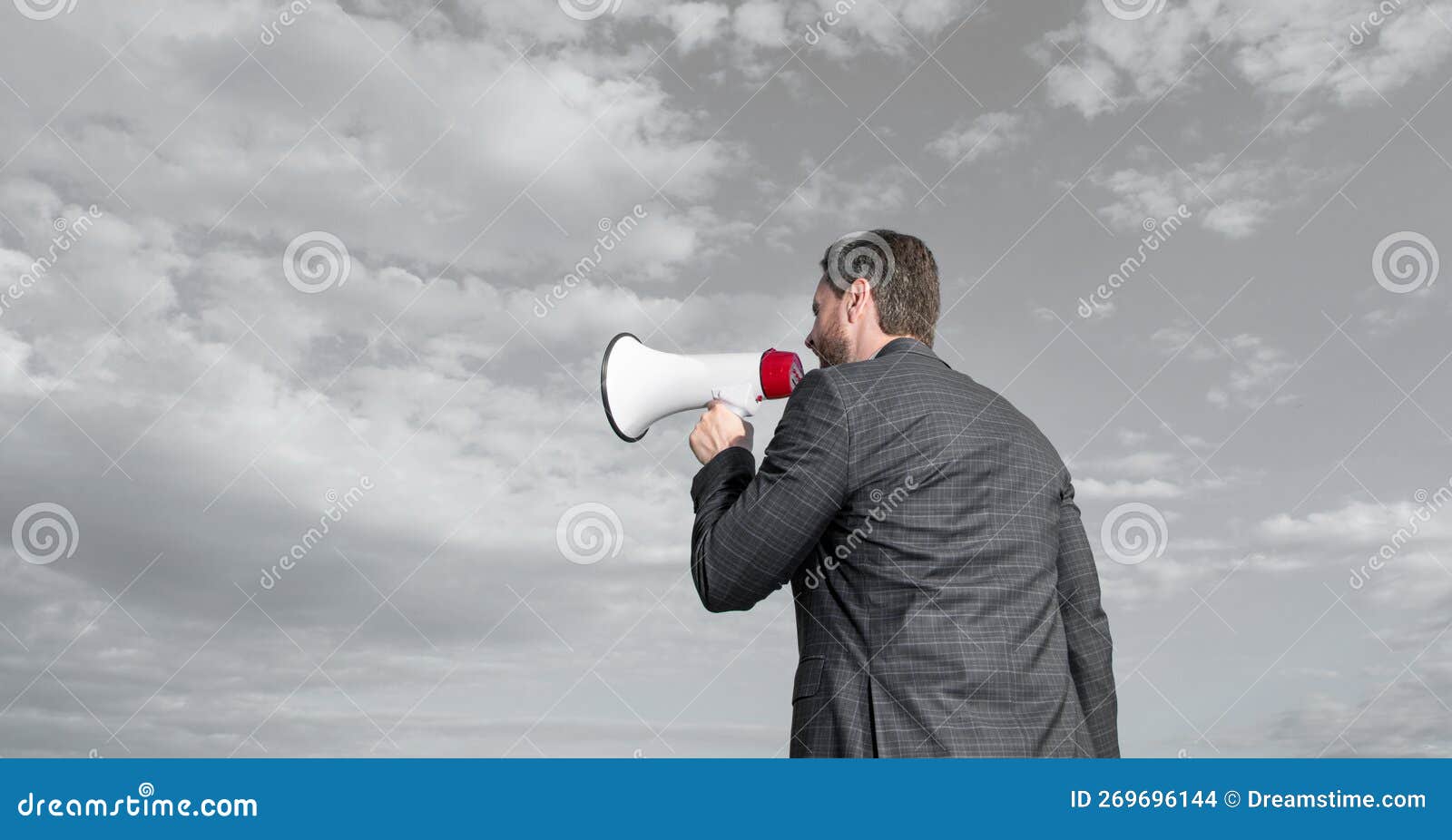 Back View of Businessman Shout in Loudspeaker on Sky Background. Copy ...