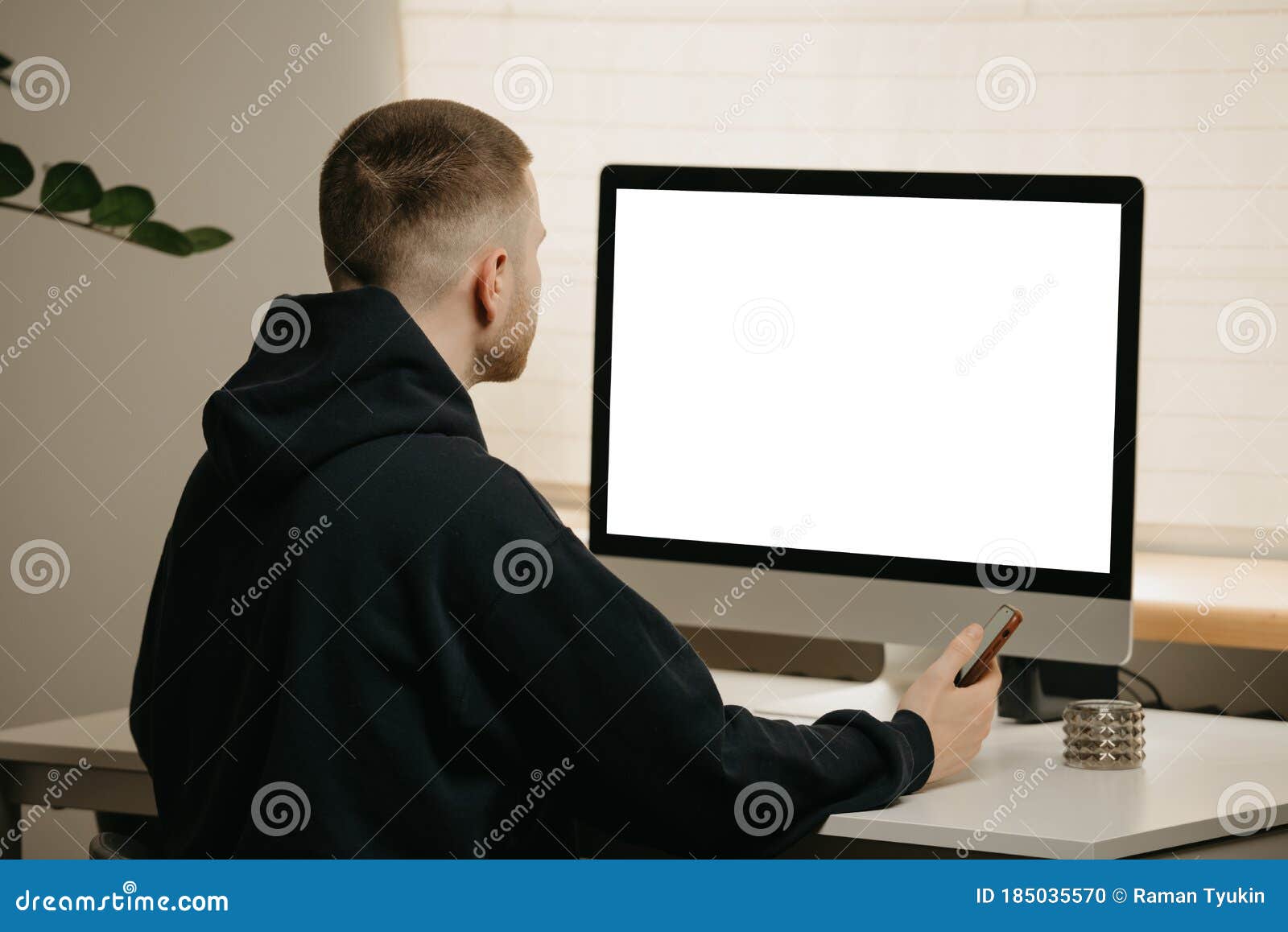 A Back View of a Businessman Works Remotely Using an All-in-one ...