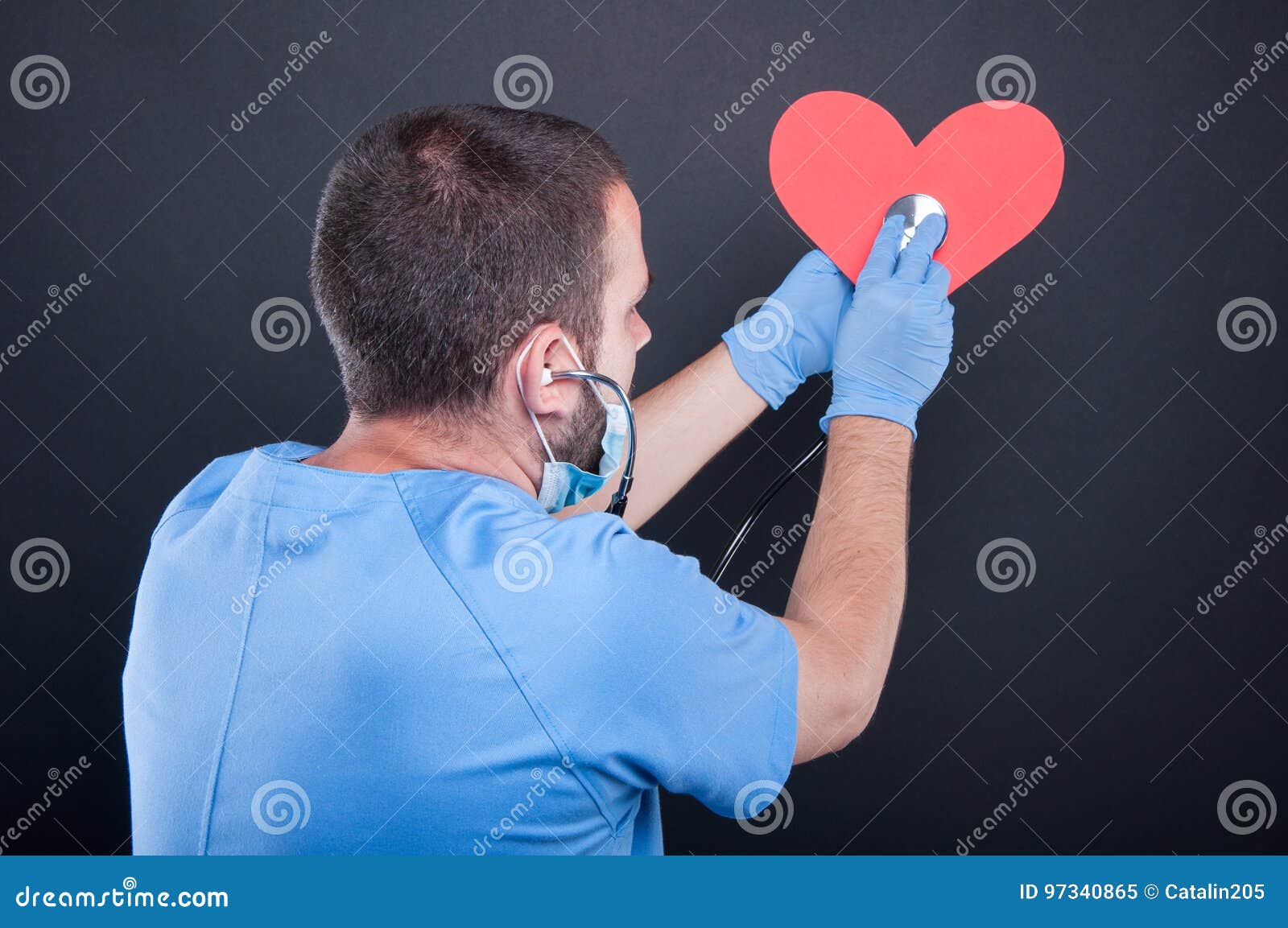 Back View of Cardiologist Using Stethoscope on Red Shape Heart Stock ...