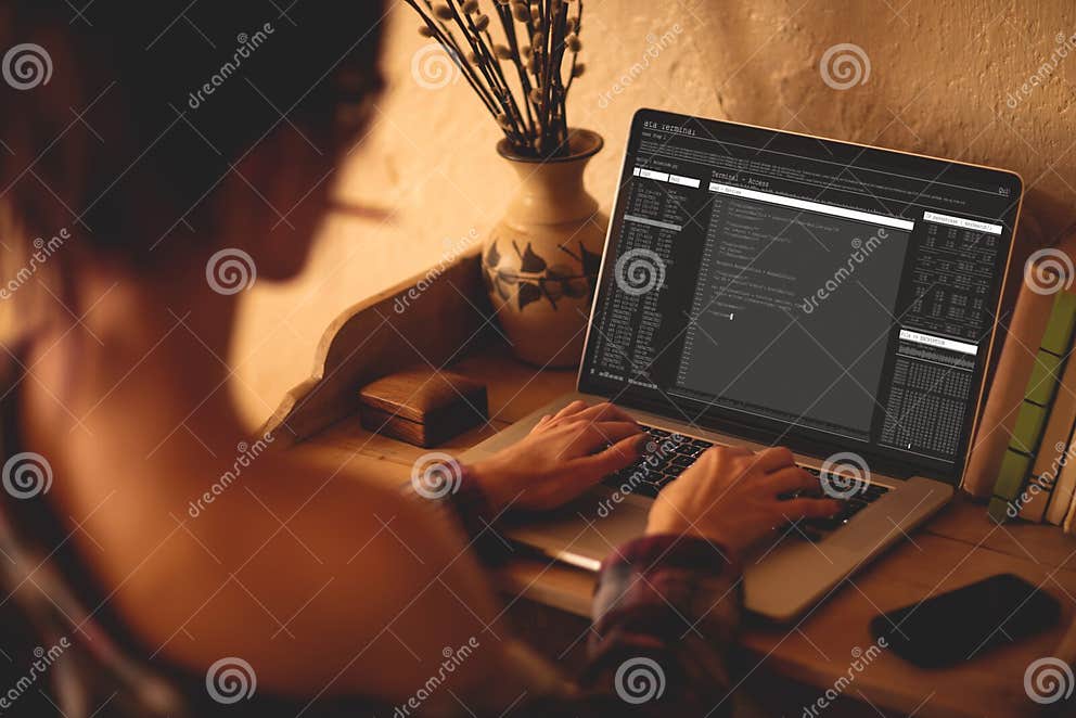 Back View of Caucasian Female Programmer Sitting at Desk, Using Laptop with Coding on Screen ...