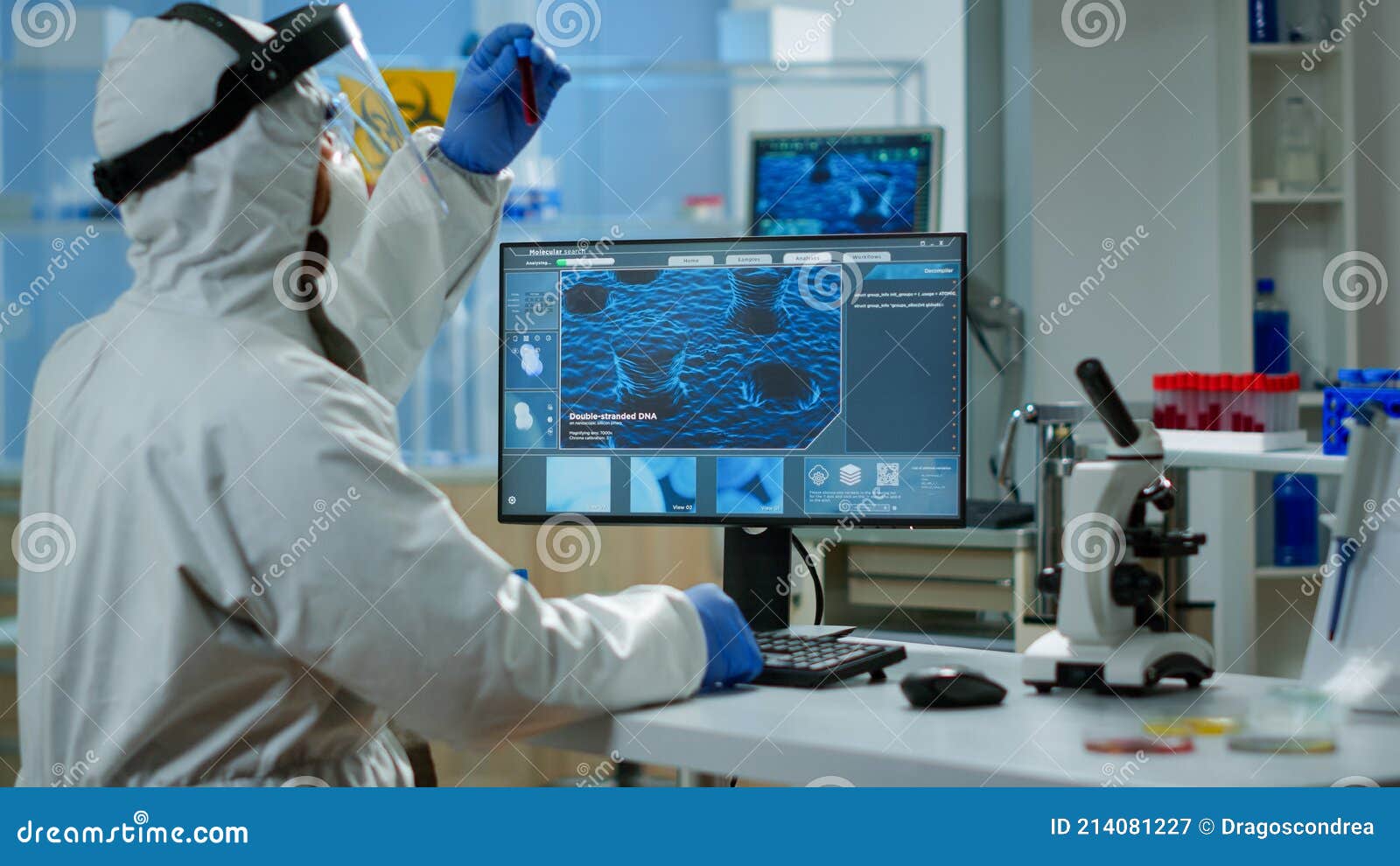 Back View Of Chemist Man In Coverall Typing On Computer Analysing ...