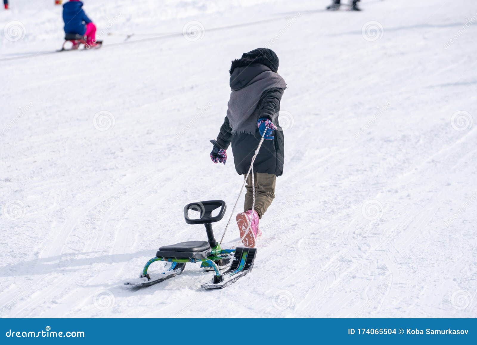 Back View of Child in Pulling Sledge and Running Up Snowy Slope Stock ...