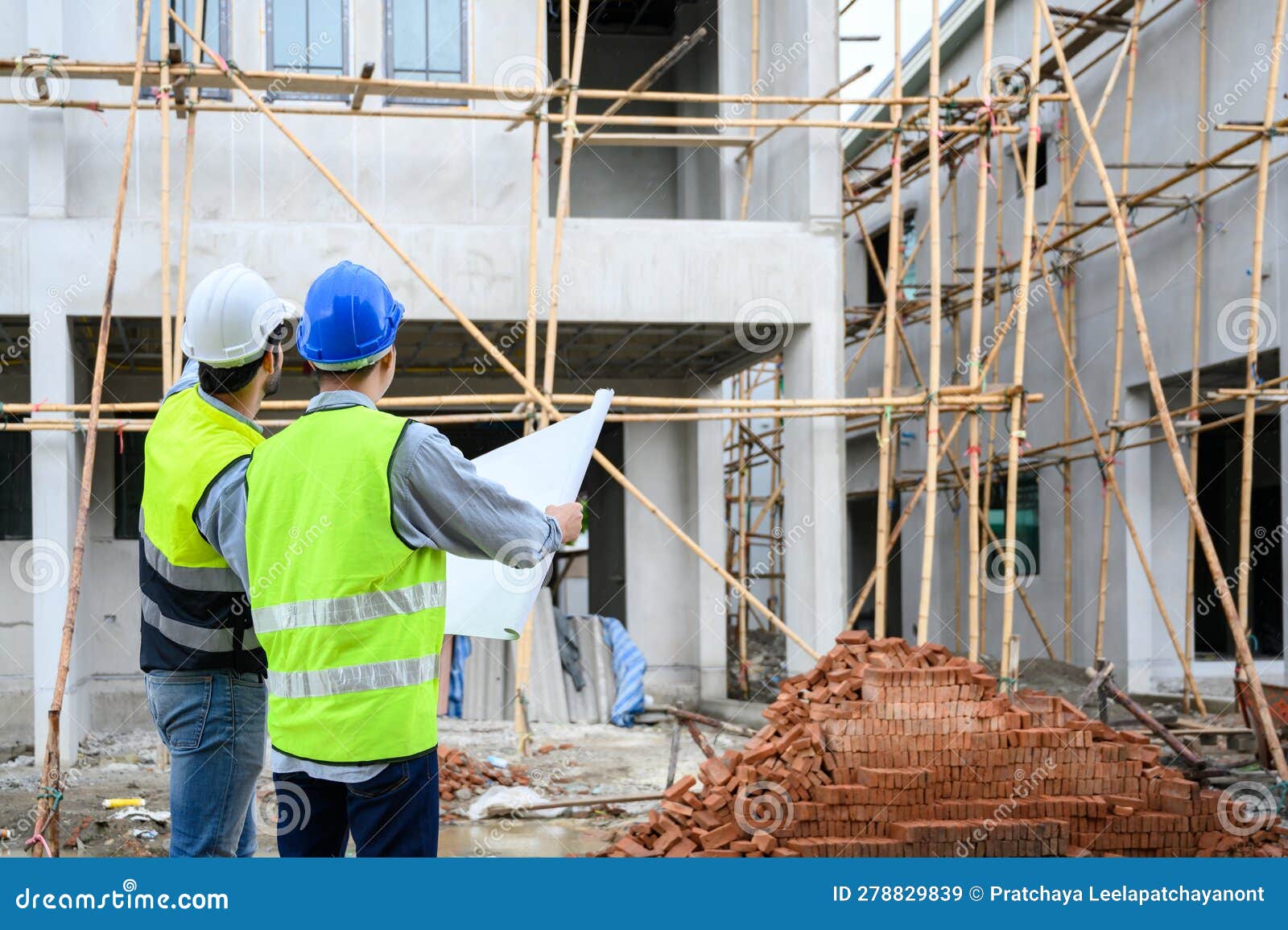 Back View of Construction Engineer and Architect Check Plan Working ...