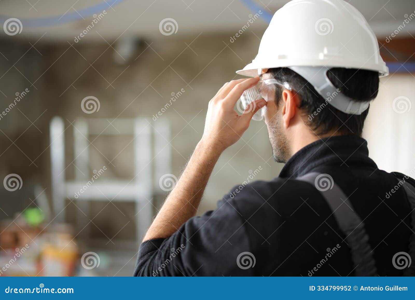 Back View of Construction Worker Putting Protective Glasses Stock Photo ...