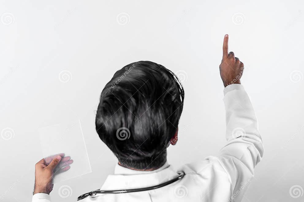 Back View of Doctor Pointing at Medical Data by Using VR Goggles ...