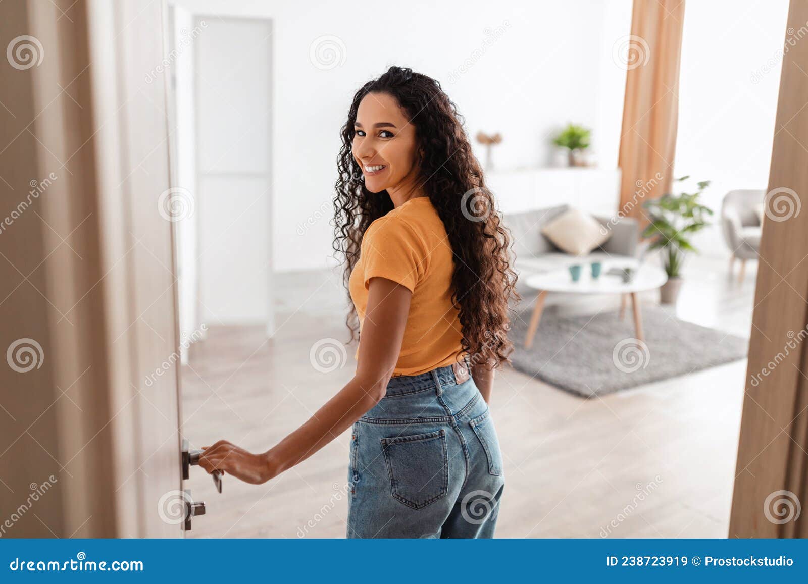 Back View Of Excited Young Woman Walking In Apartment Stock Image