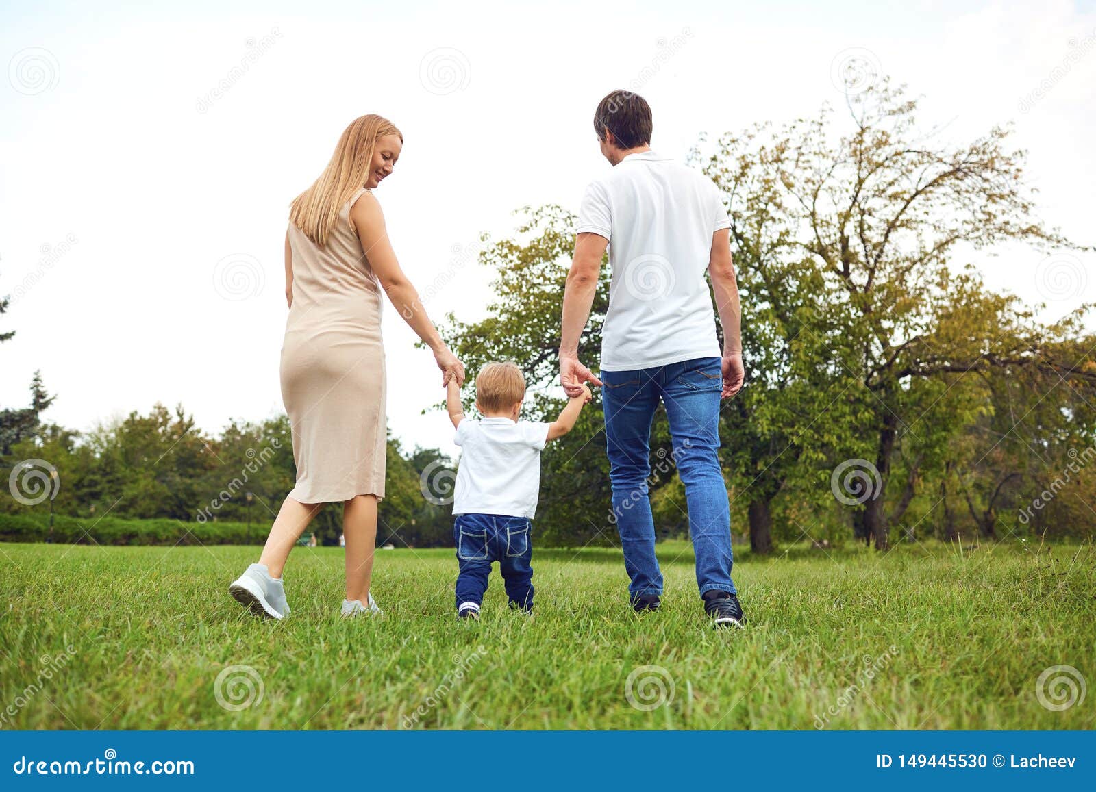 Back View. Family with a Child Walks in the Park. Stock Photo - Image ...