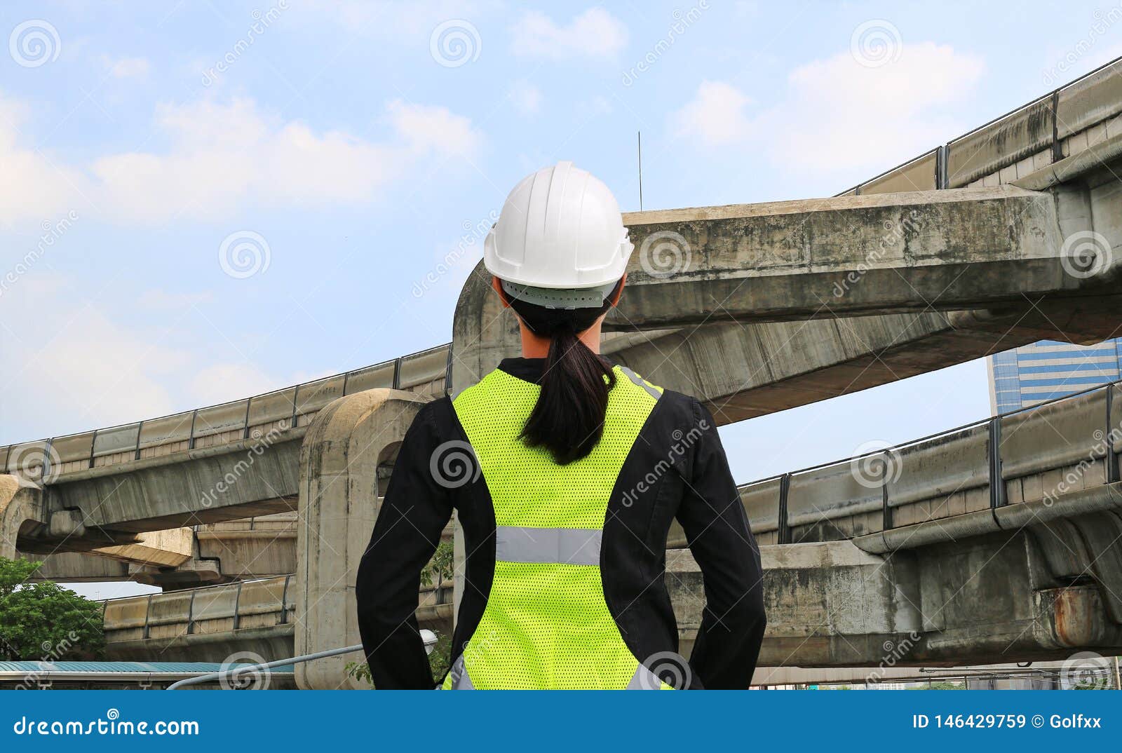 Back View of Female Construction Worker Against Expressway Background ...