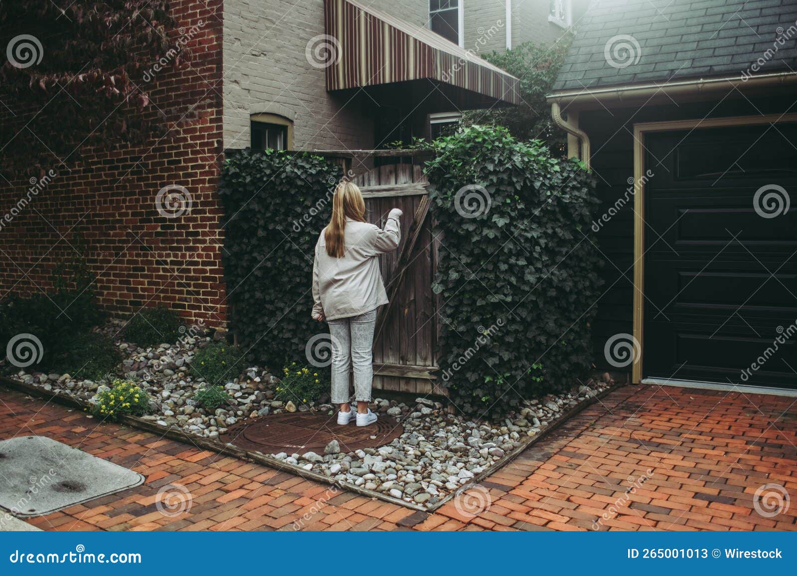 Back View of a Female in Front of the Brick Wall Building Stock Image ...