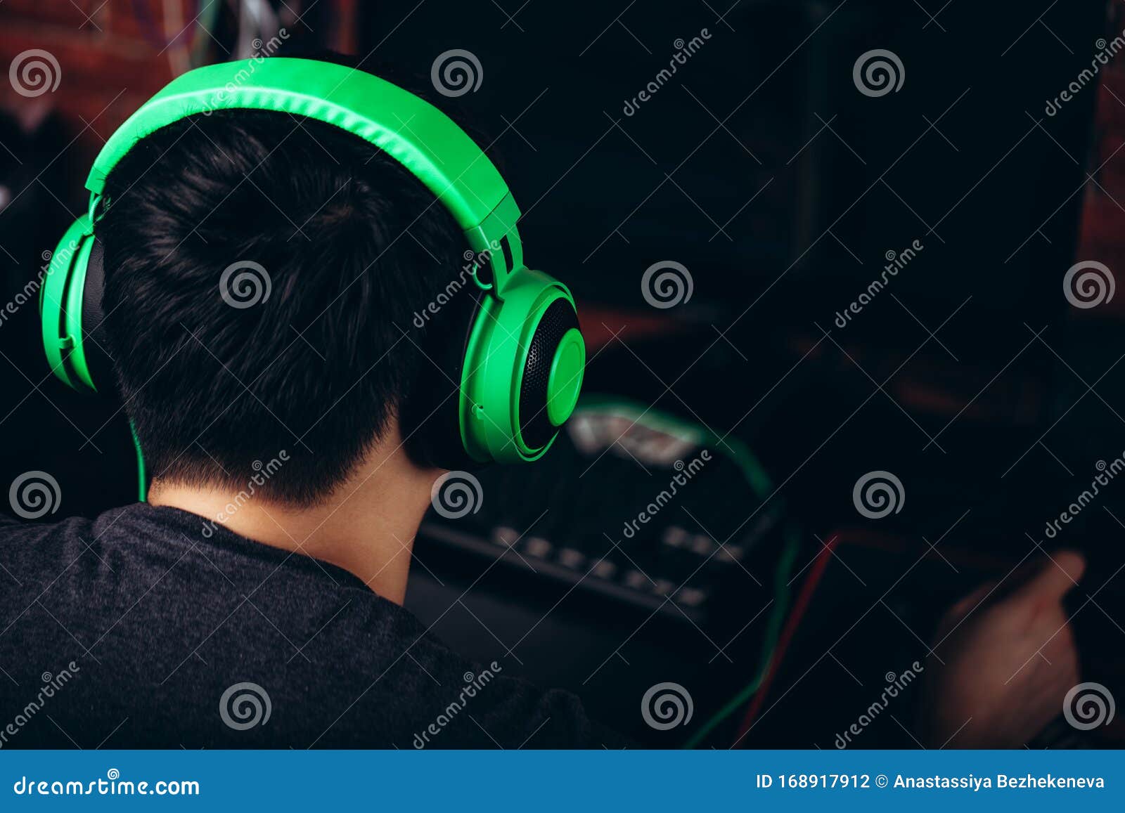 Back View of Gamer in Headphones Playing Video Game Stock Photo - Image ...
