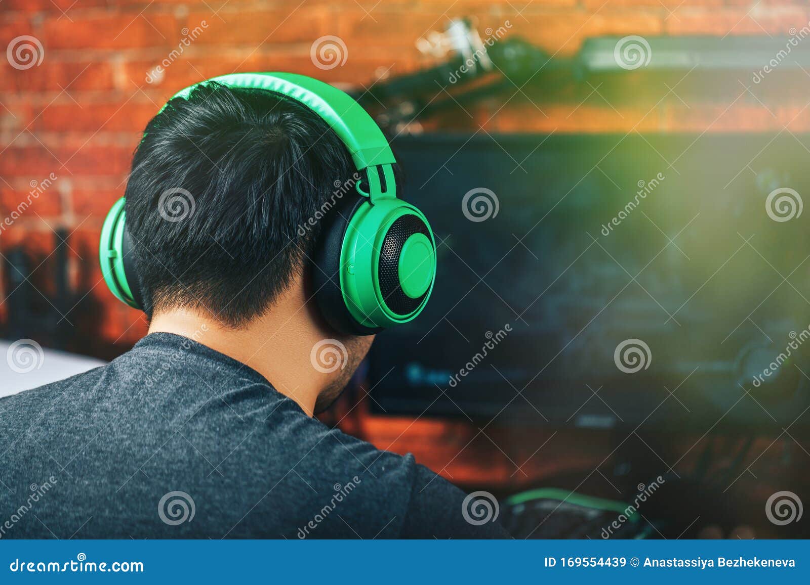 Back View of Gamer in Headphones Playing Video Game Stock Image - Image ...