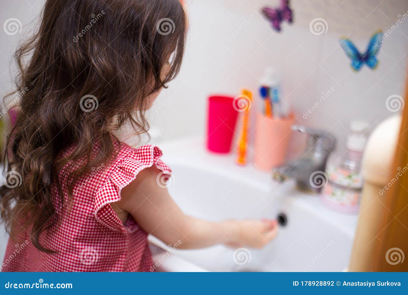 Back View. Girl Child Washes Hands with Soap in the Bathroom Stock ...