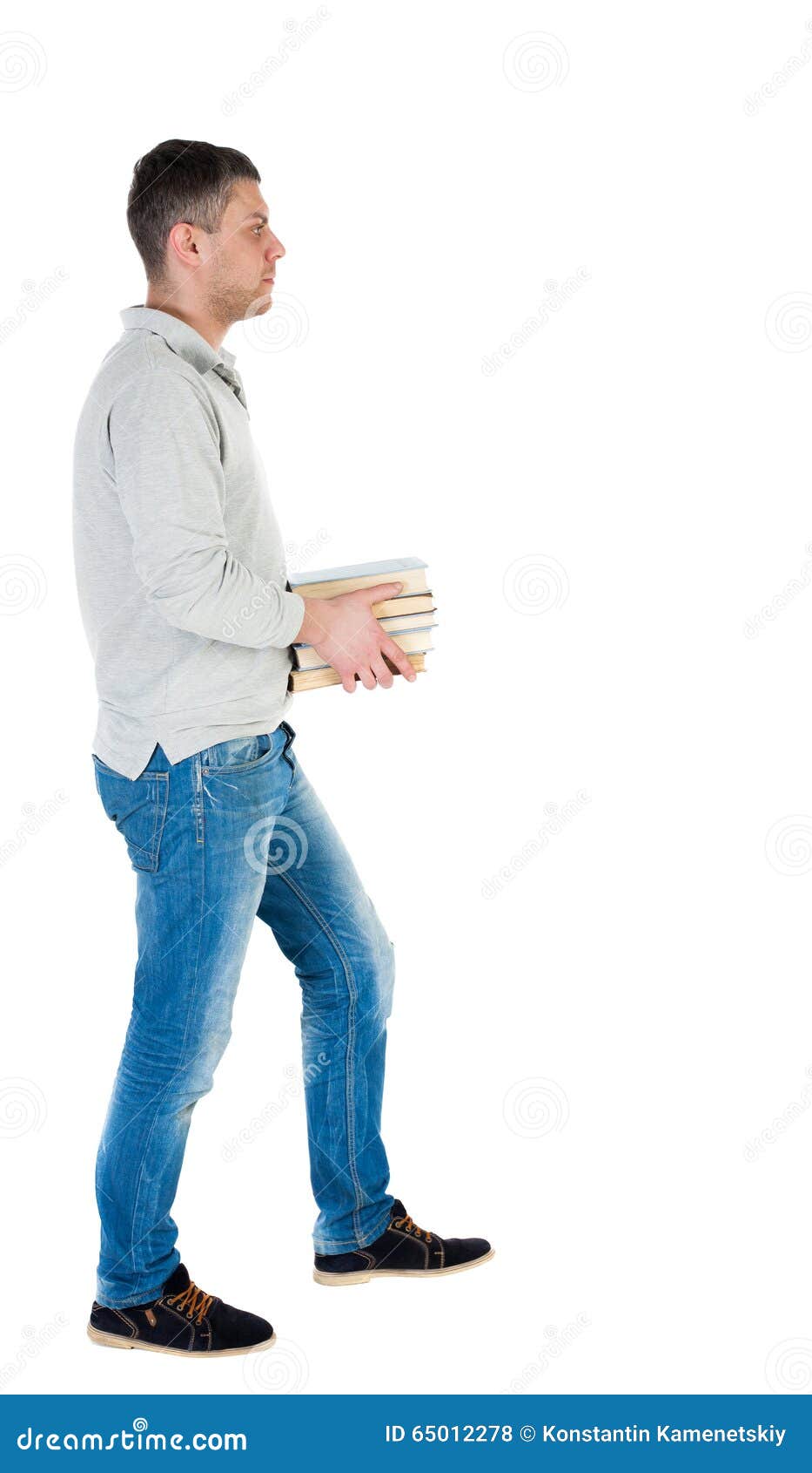 Back View of Going Handsome Man Carries a Stack of Books. Stock Photo ...