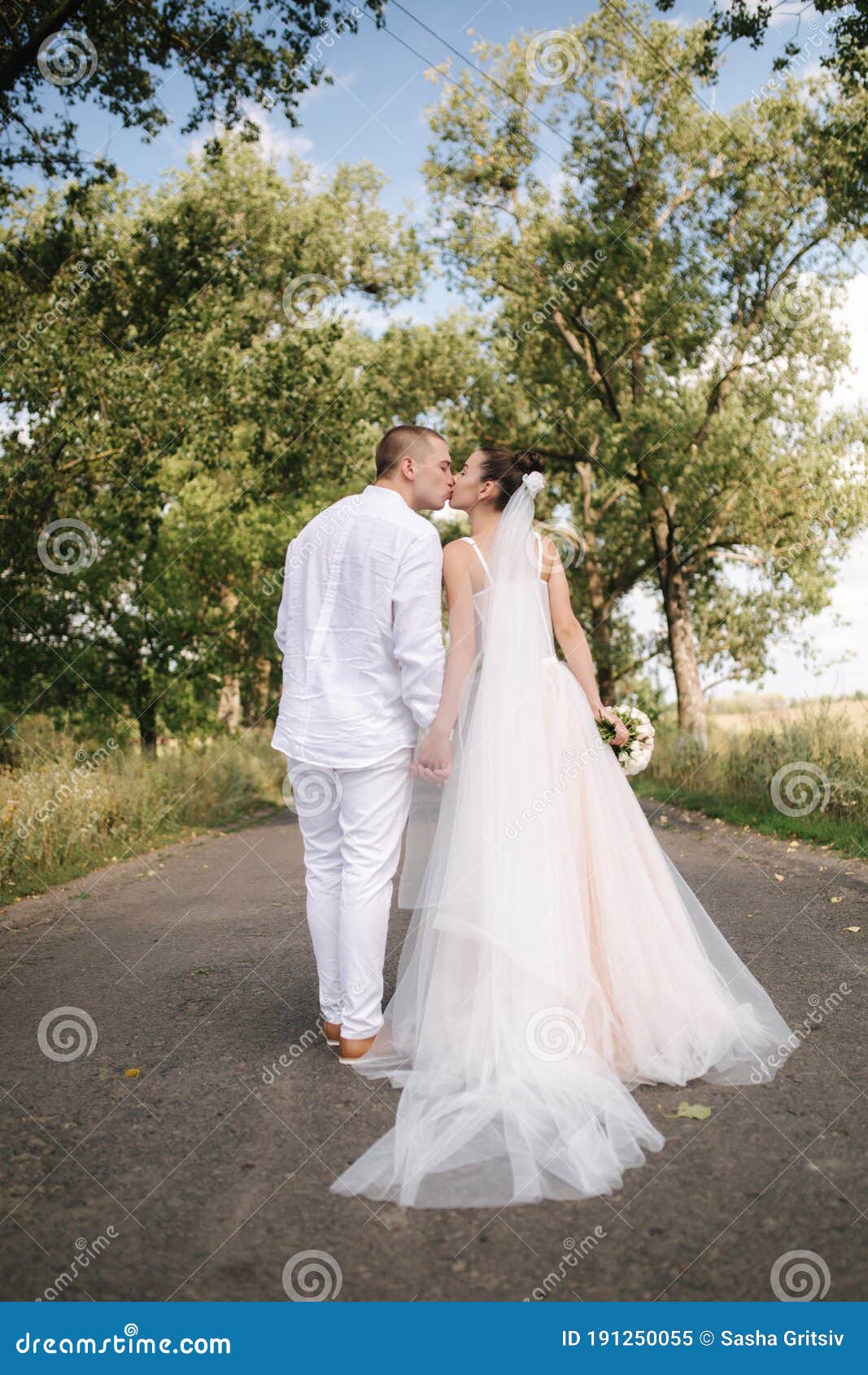 Back View of Groom and Bride Walking in Linden Aley in Wedding Day ...