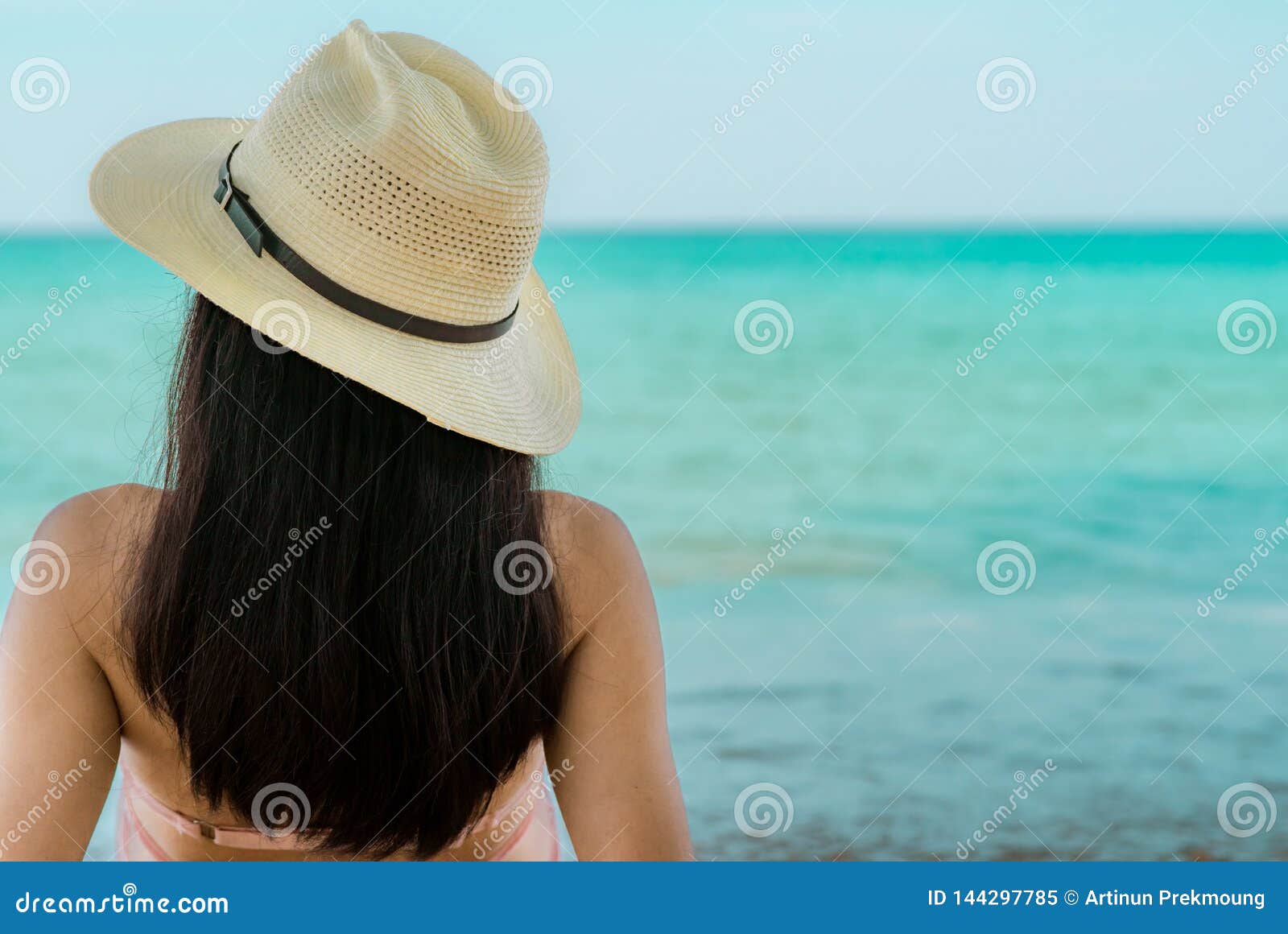 Back View Of Happy Young Asian Woman In Pink Swimsuit And Straw Hat