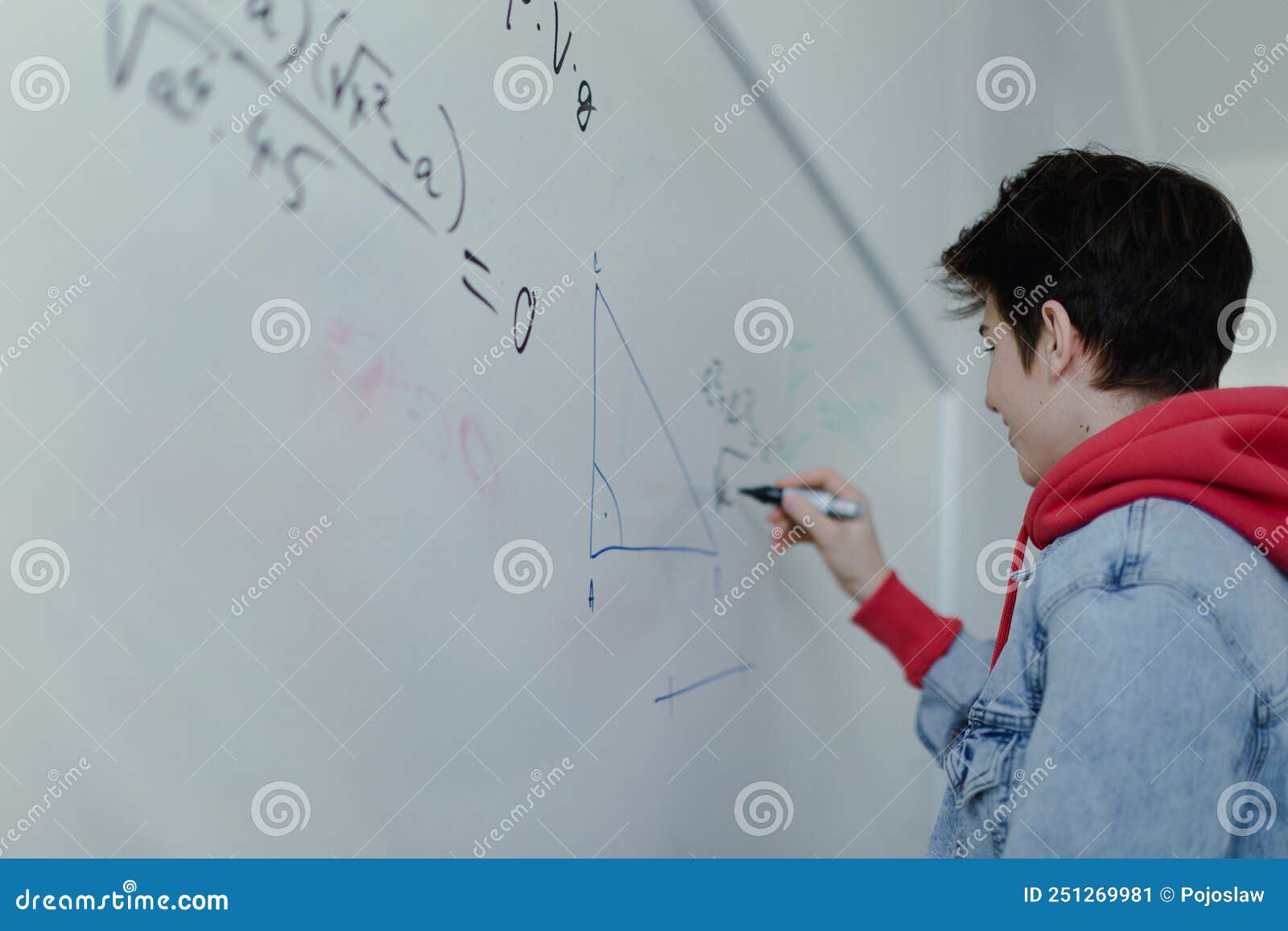Back View of High School Student Solving Math Problem on Whiteboard in ...