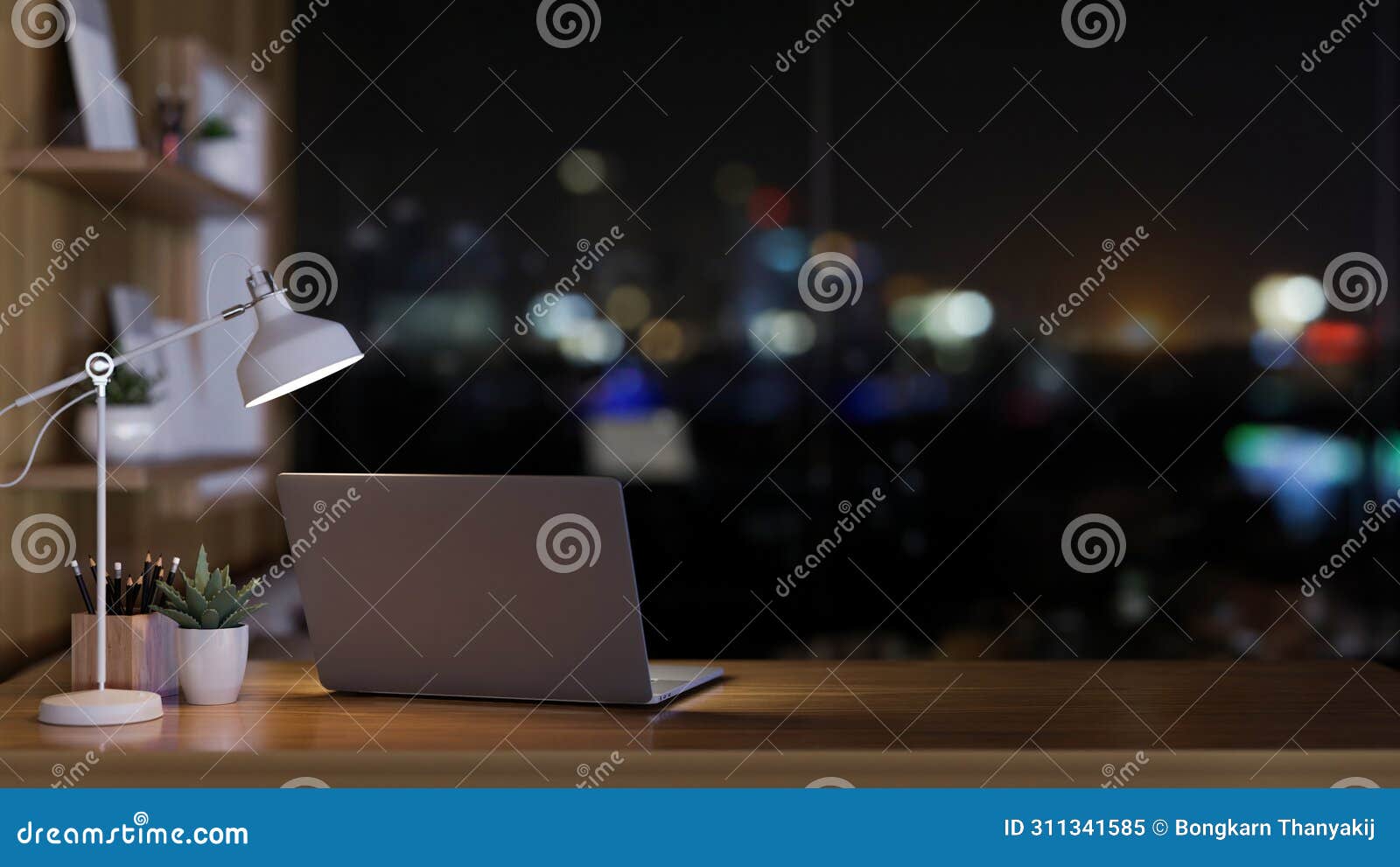 A Laptop Computer, a Table Lamp, and Decor on a Desk Near the Window ...