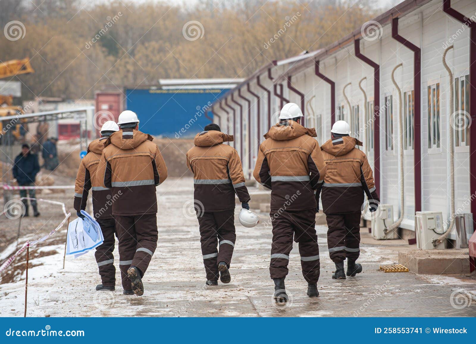 Back View of Industrial Construction Workers Wearing Uniform on a Cold ...