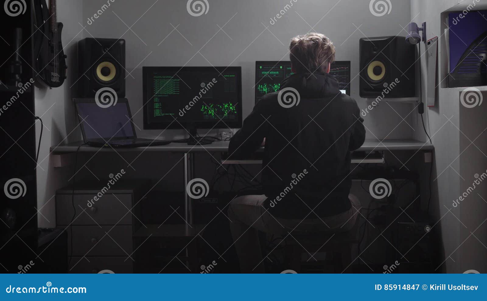 Back View of a Man in Black Clothes Sitting at the Table. Cyber Spy is ...