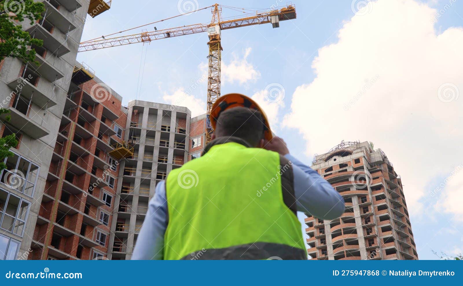 Back View of Man Builder in Uniform Standing in Front of Construction ...