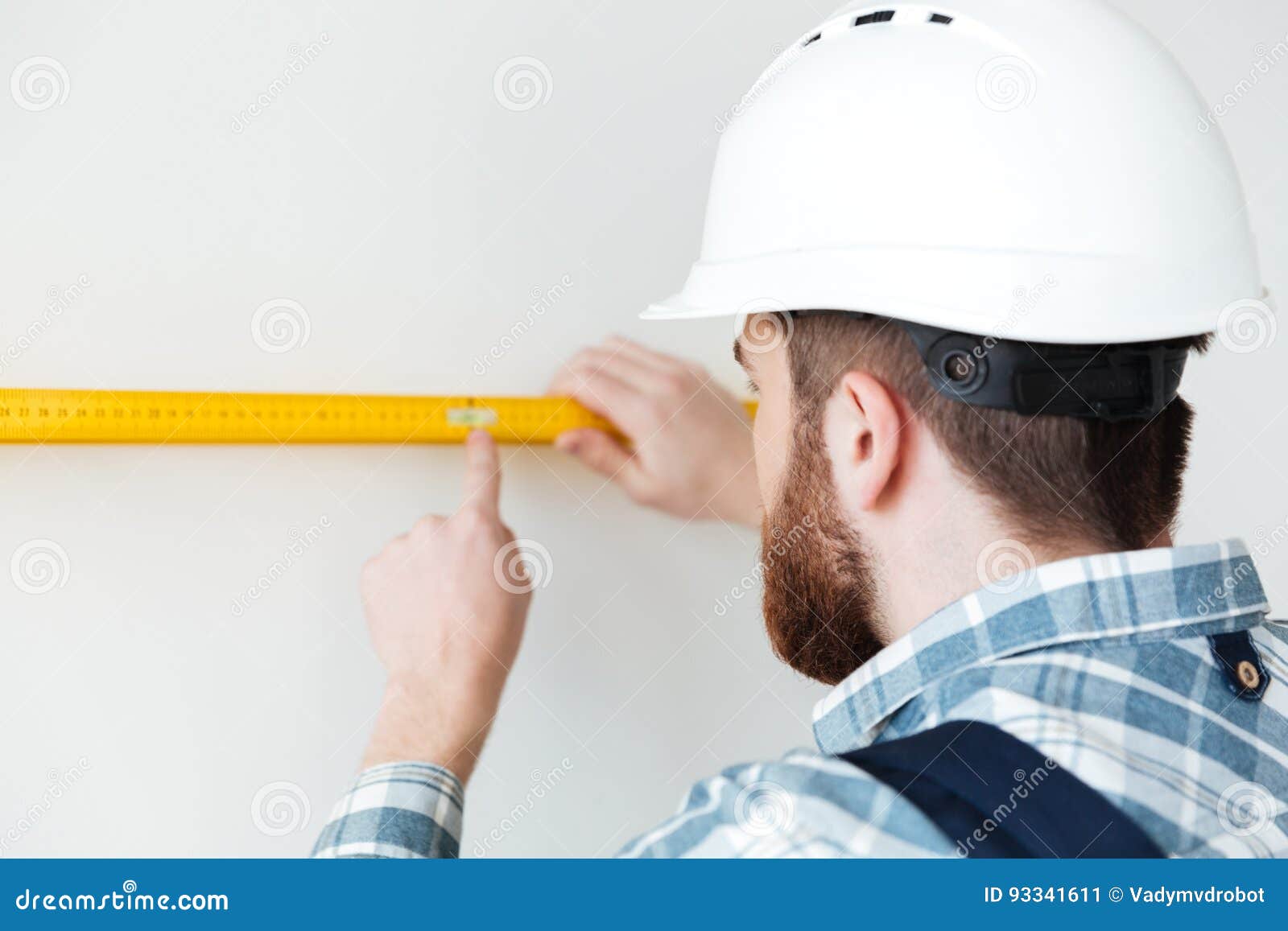 Back View of Man Builder Using Ruler To Measure Length Stock Image ...