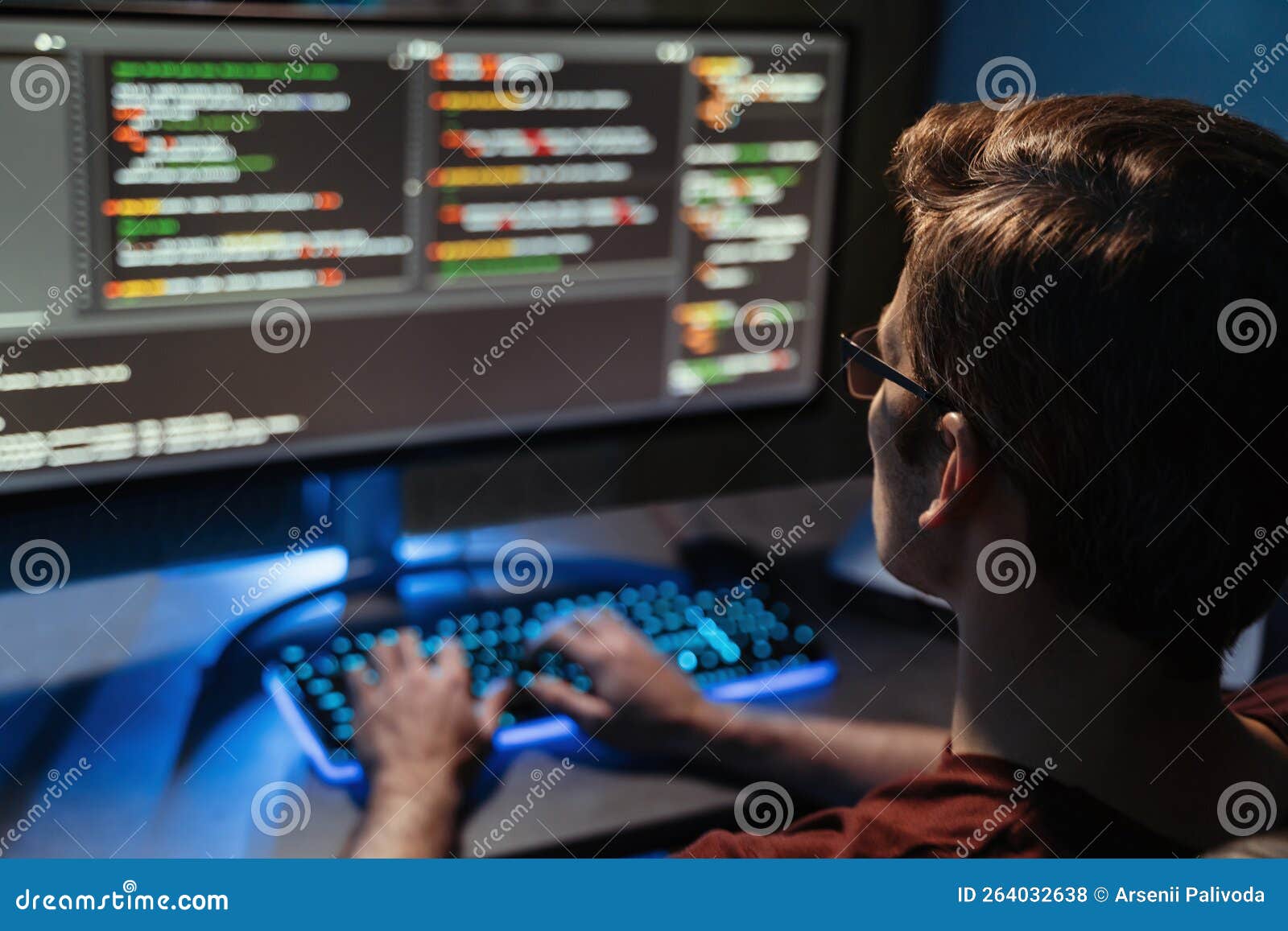 Back View Of Man Coding For Cyber Security Programming And Working From Home At Pc Screen Stock